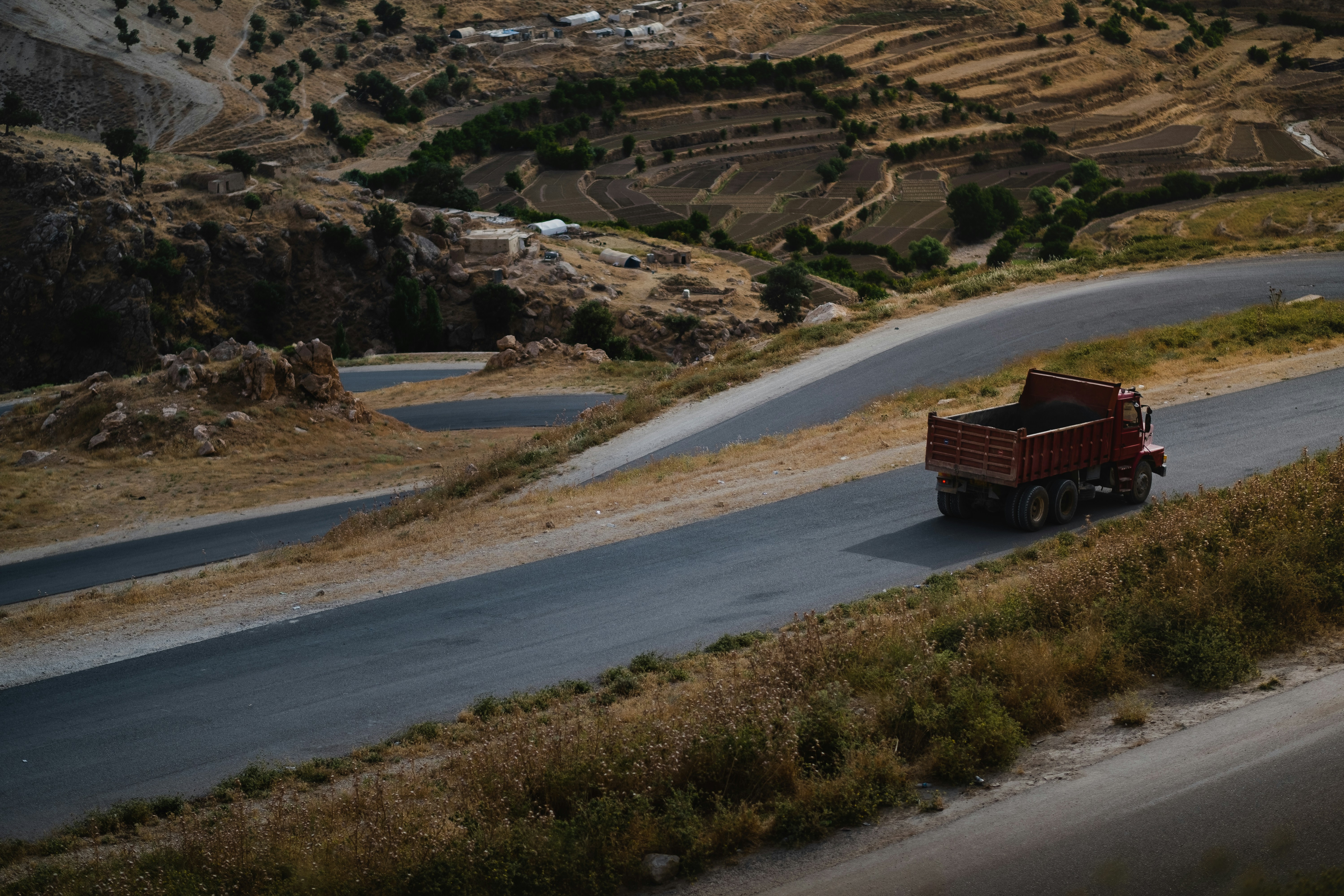 Red Dump Truck Conquers a Winding Mountain Switchback