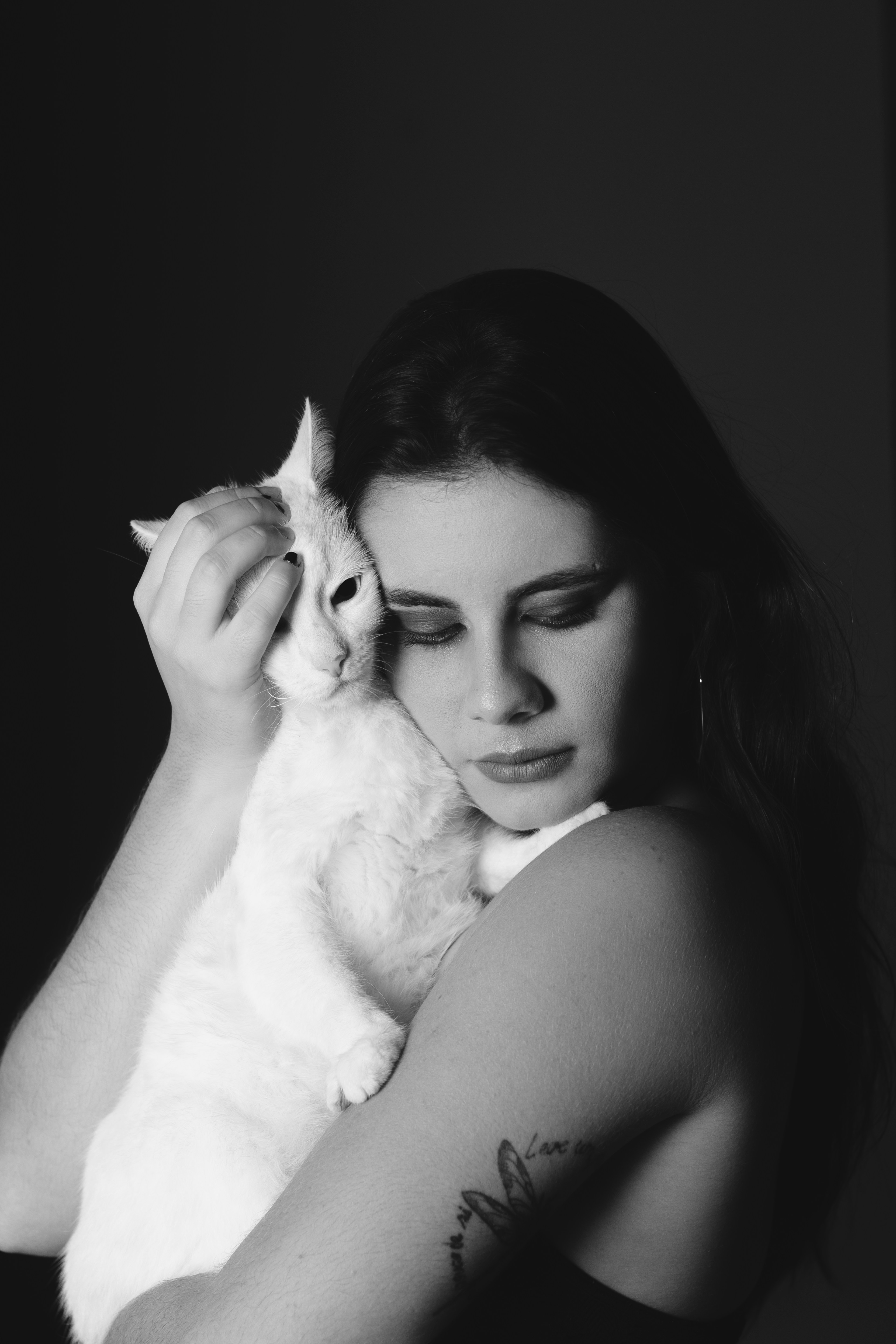 Monochrome Embrace: Tender Bond Between Woman and Cat