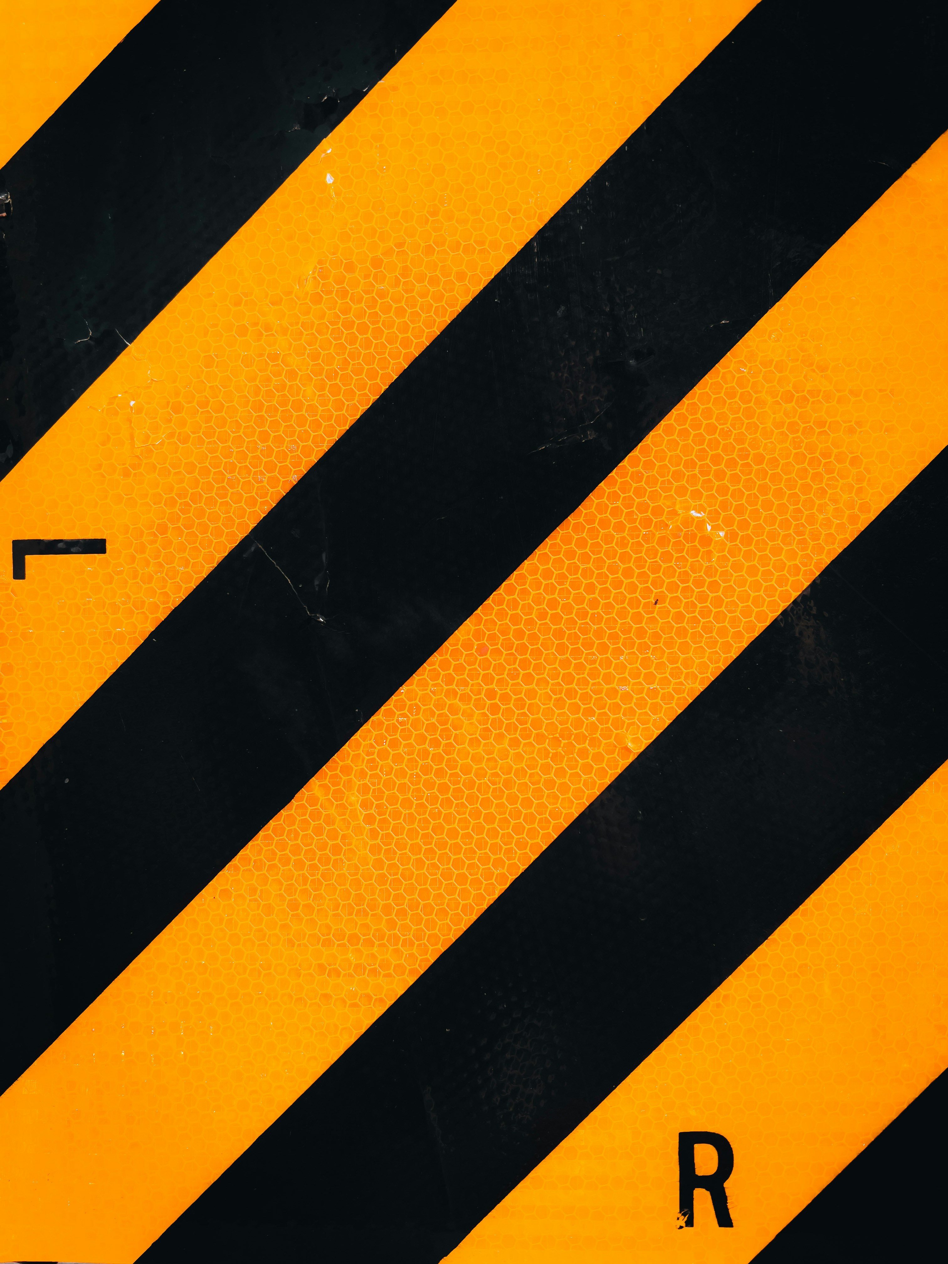 A close up of a black and yellow hazard sign photo – Free Orange Image ...