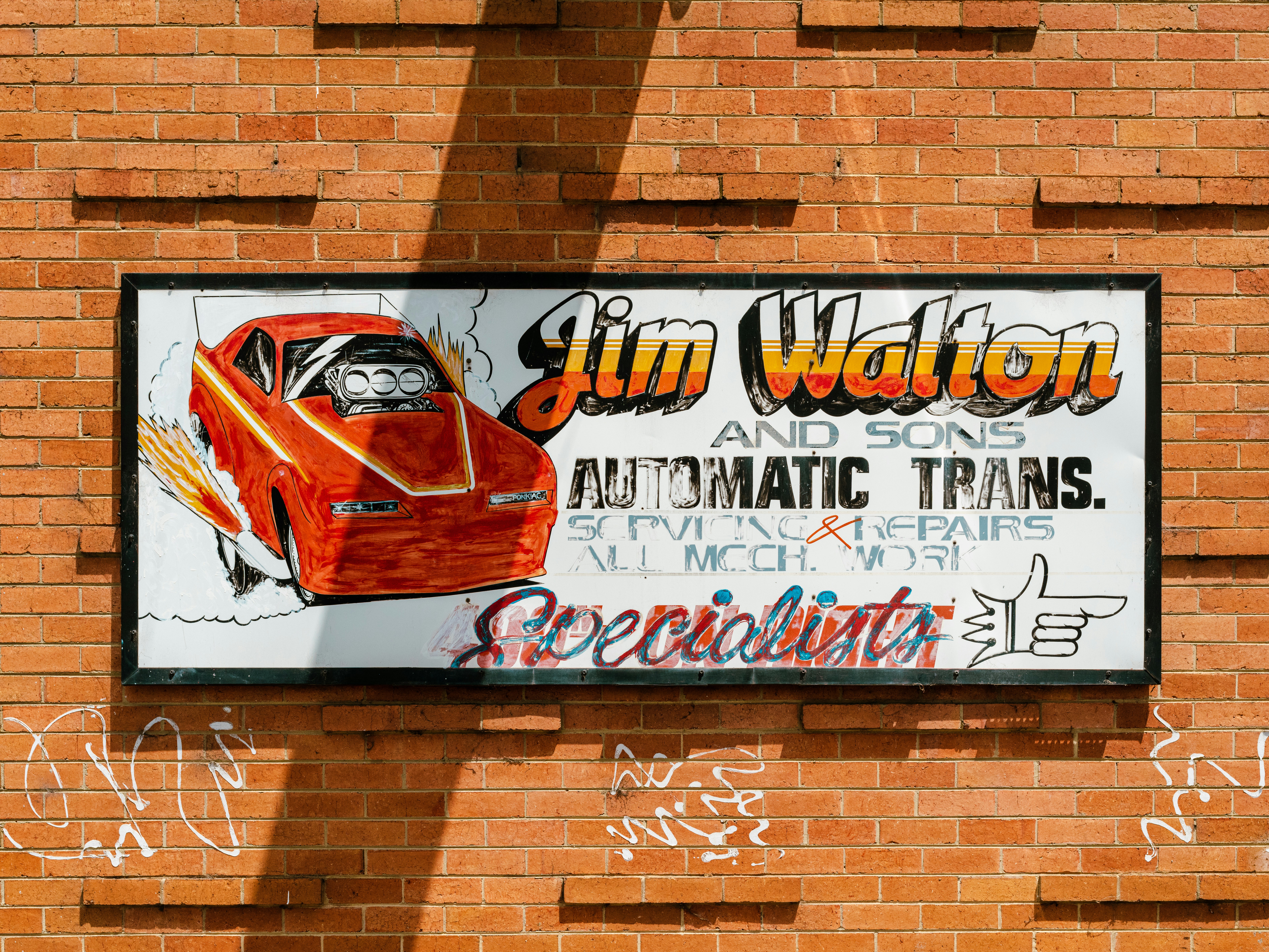 Retro Automotive Mural on Brick Canvas