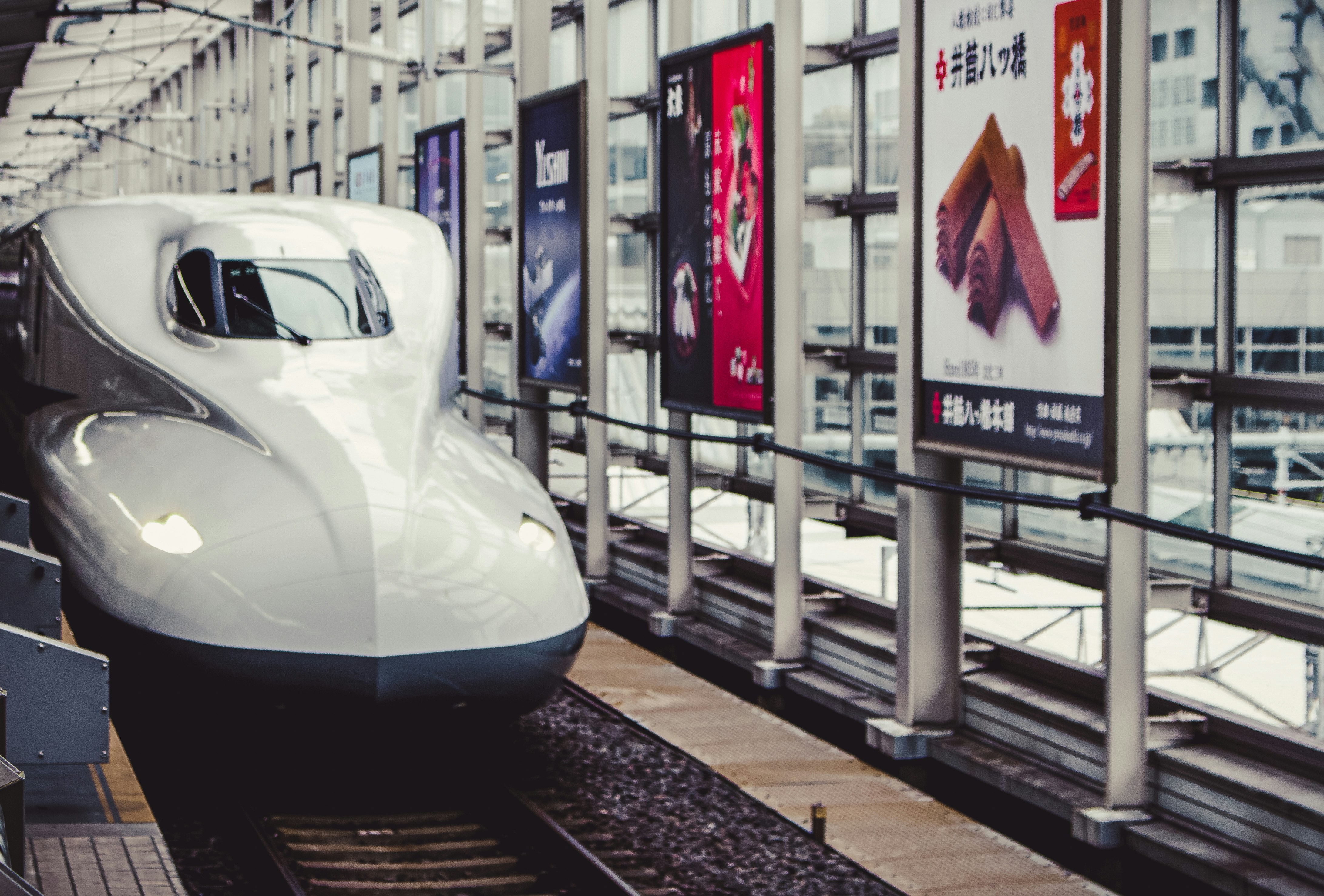 A white bullet train pulling into a train station photo – Free Train ...