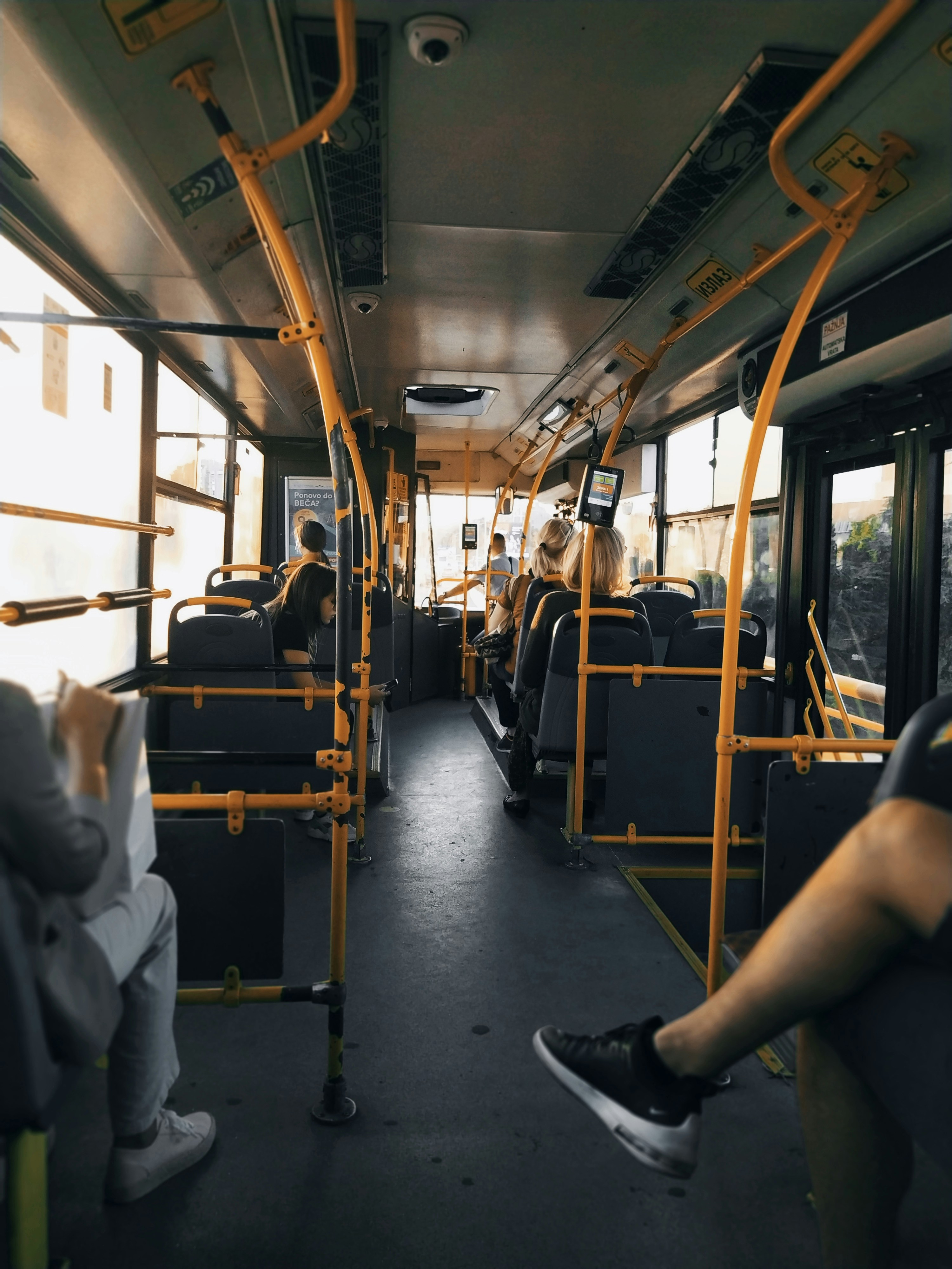 A group of people sitting on top of a bus photo – Free Bus Image on ...