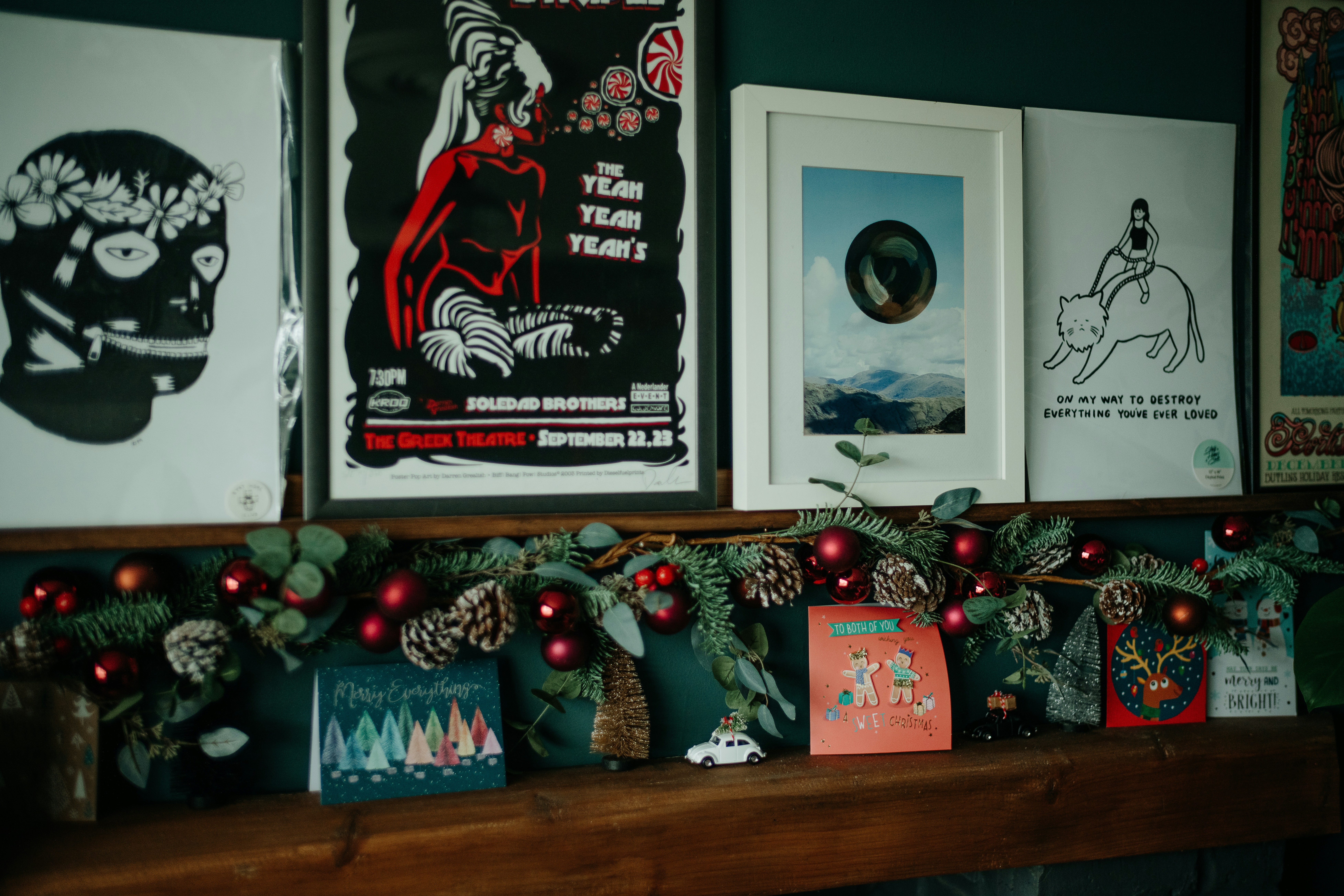 Red-Accent Poster Framed by Festive Garland on a Cozy Wall