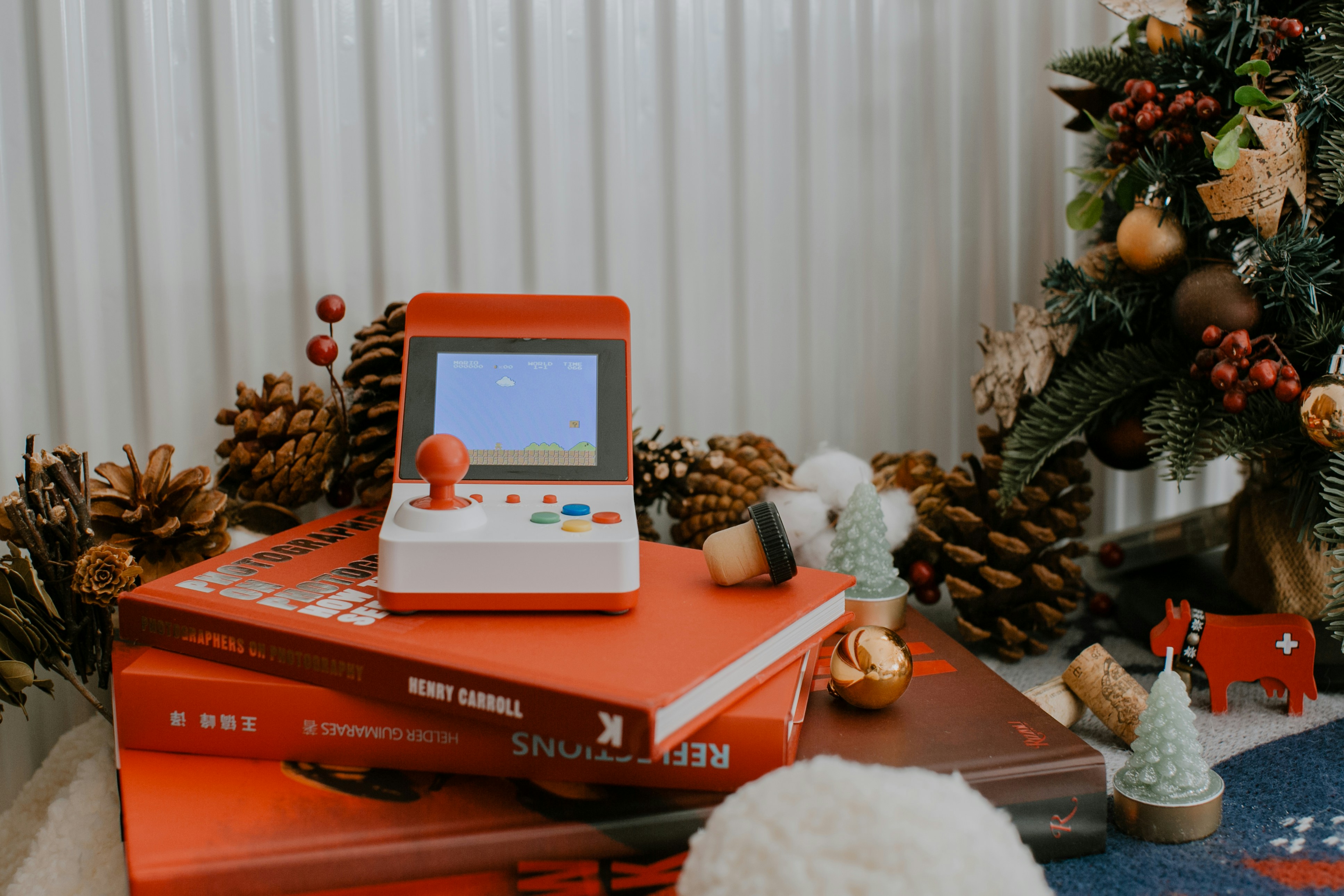 a pile of books sitting next to a christmas tree