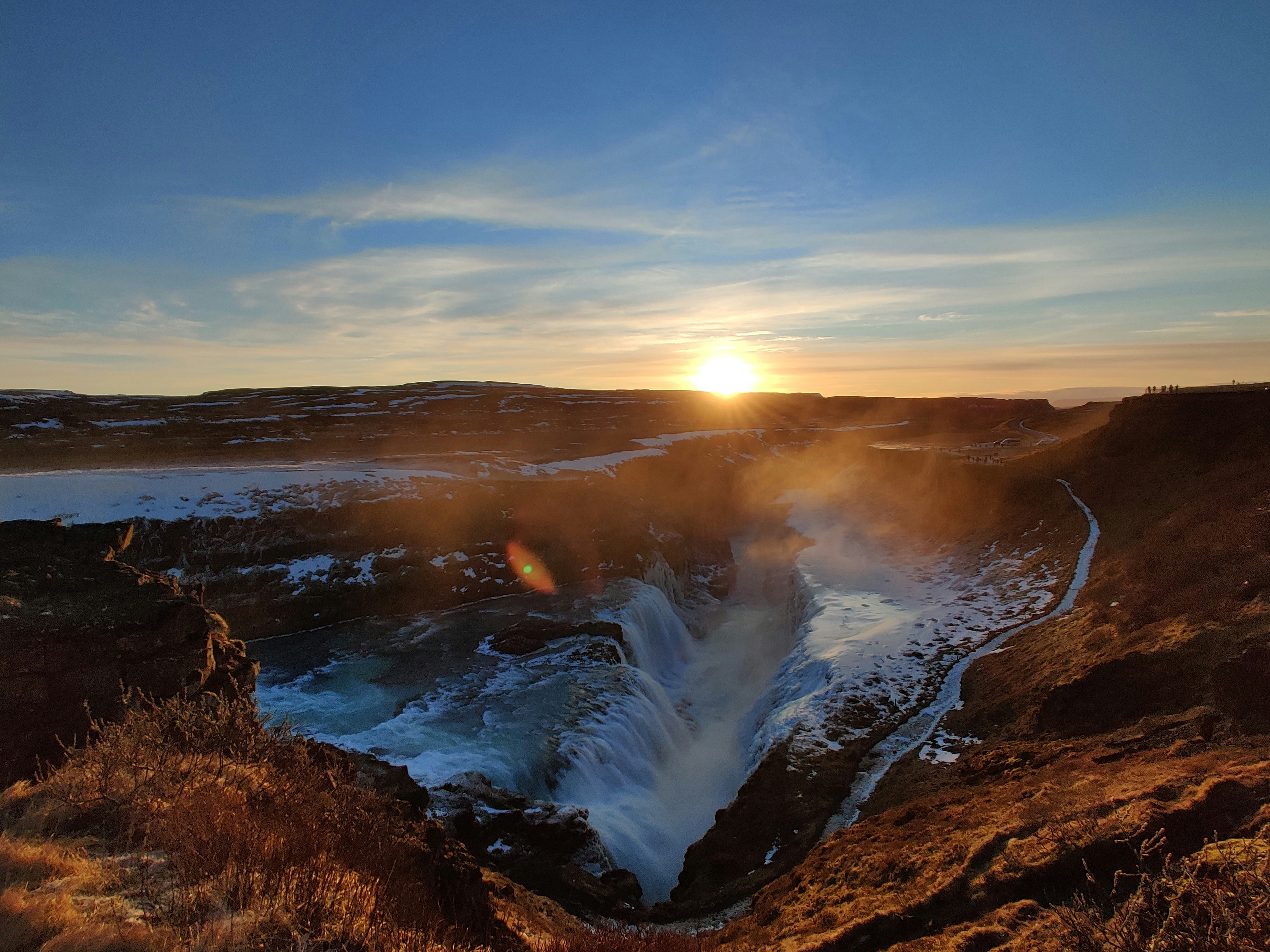 The sun is setting over a large waterfall photo – Free Gullfoss Image ...