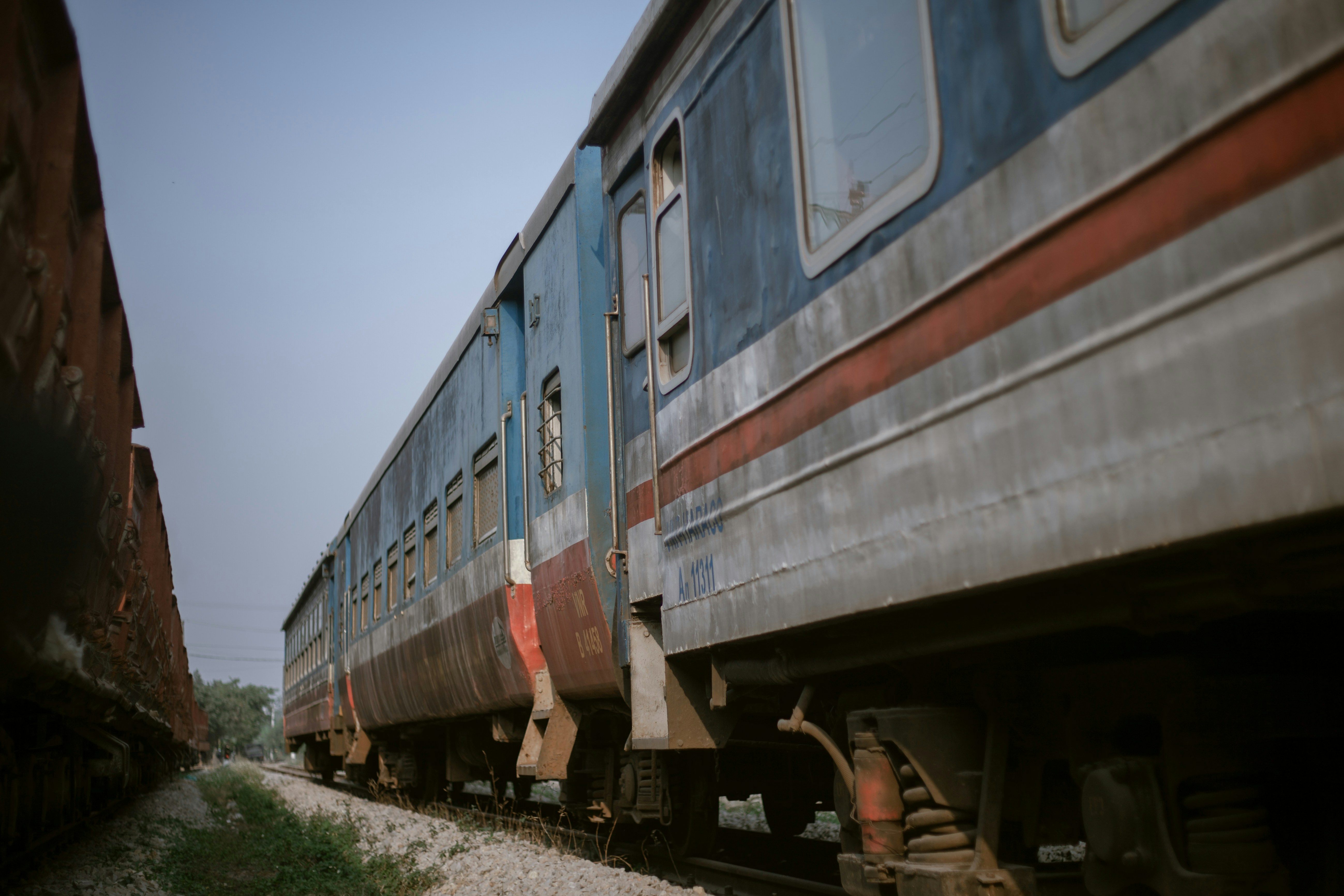 A blue and red train traveling down train tracks photo – Free Train ...