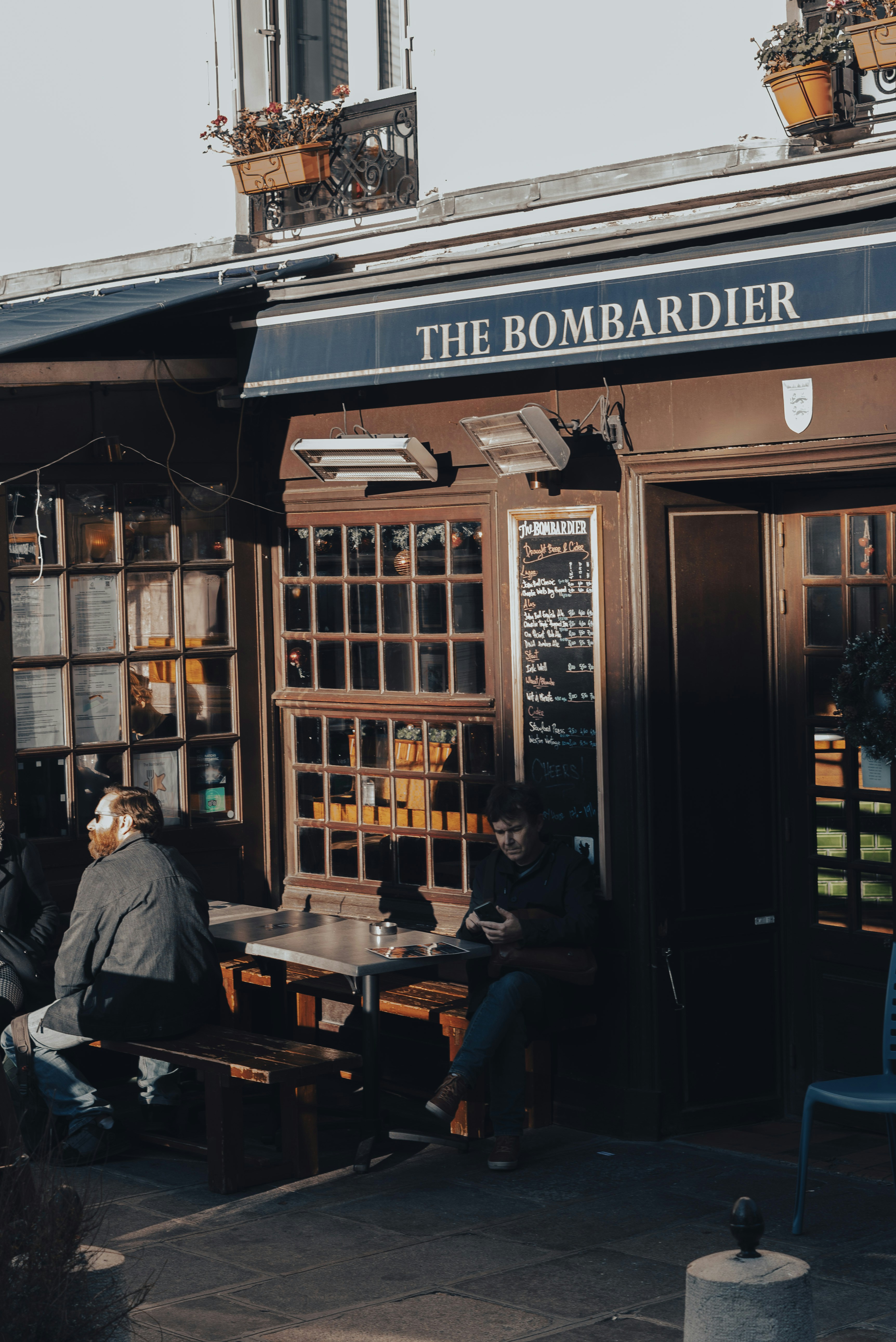 The Bombardier's Quiet Terrace: Sunlit Afternoon at a Cozy Street Café