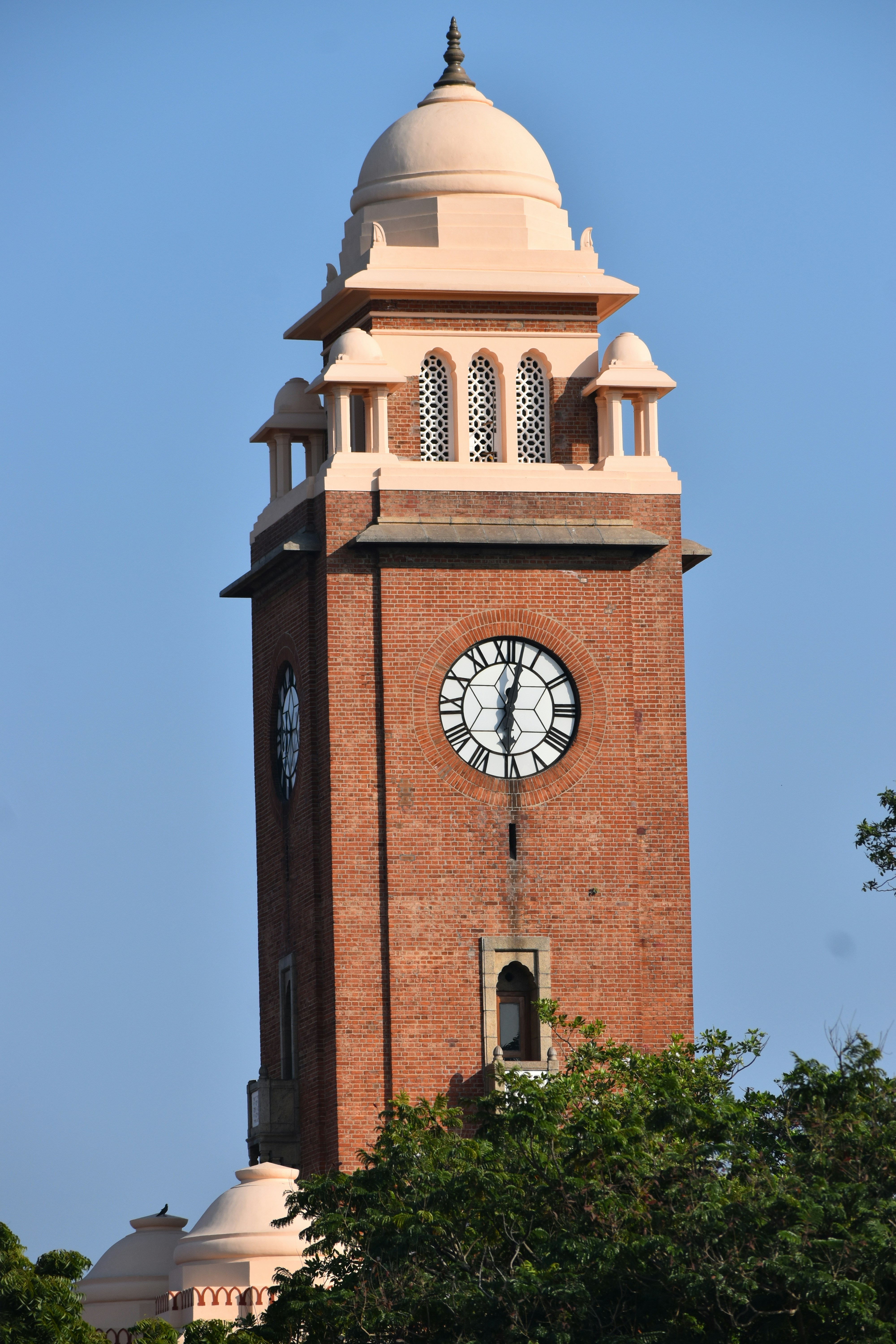 A large brick clock tower with a clock on each of it's sides photo ...