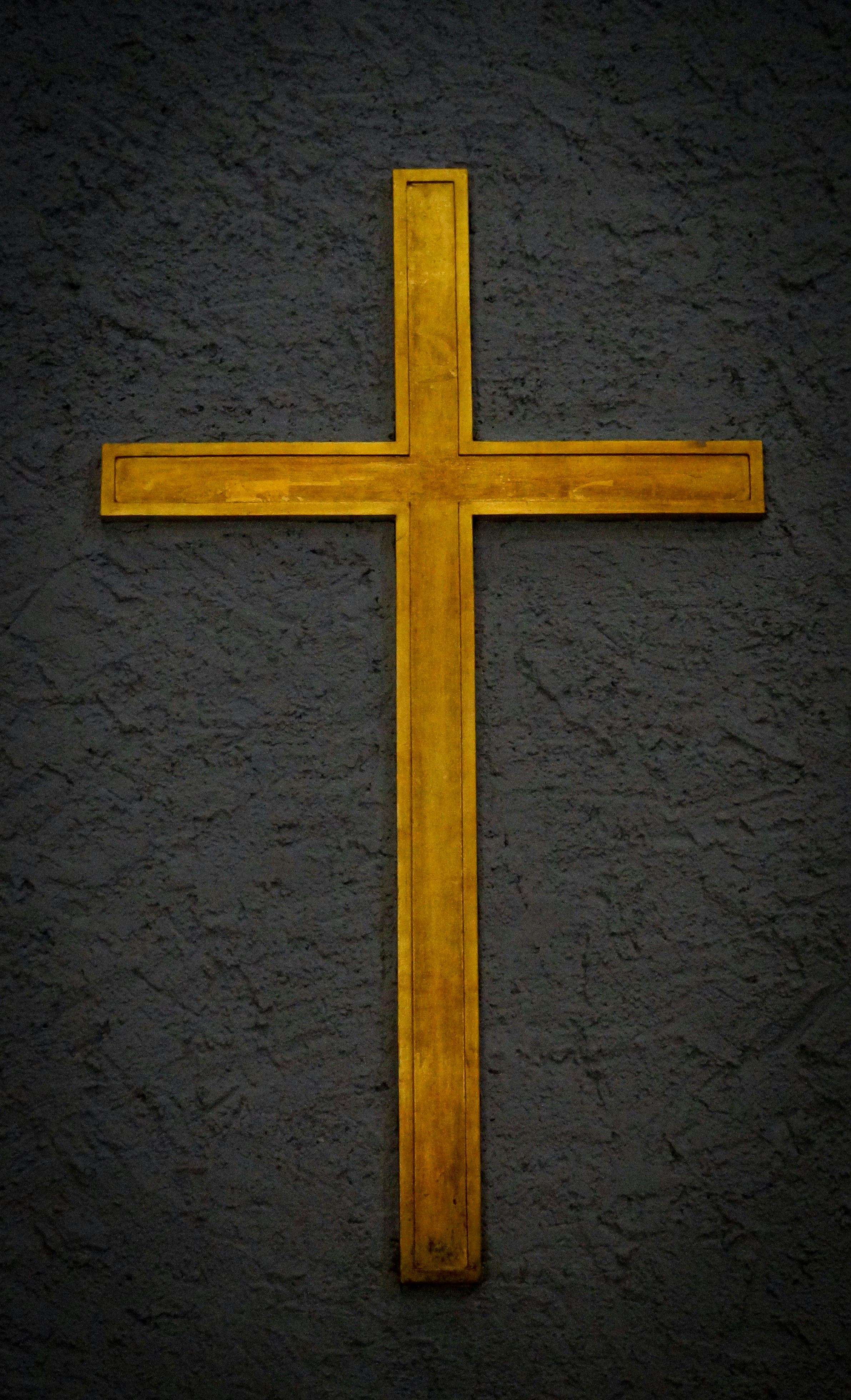 A yellow cross on a black wall photo – Free Vatican city Image on Unsplash