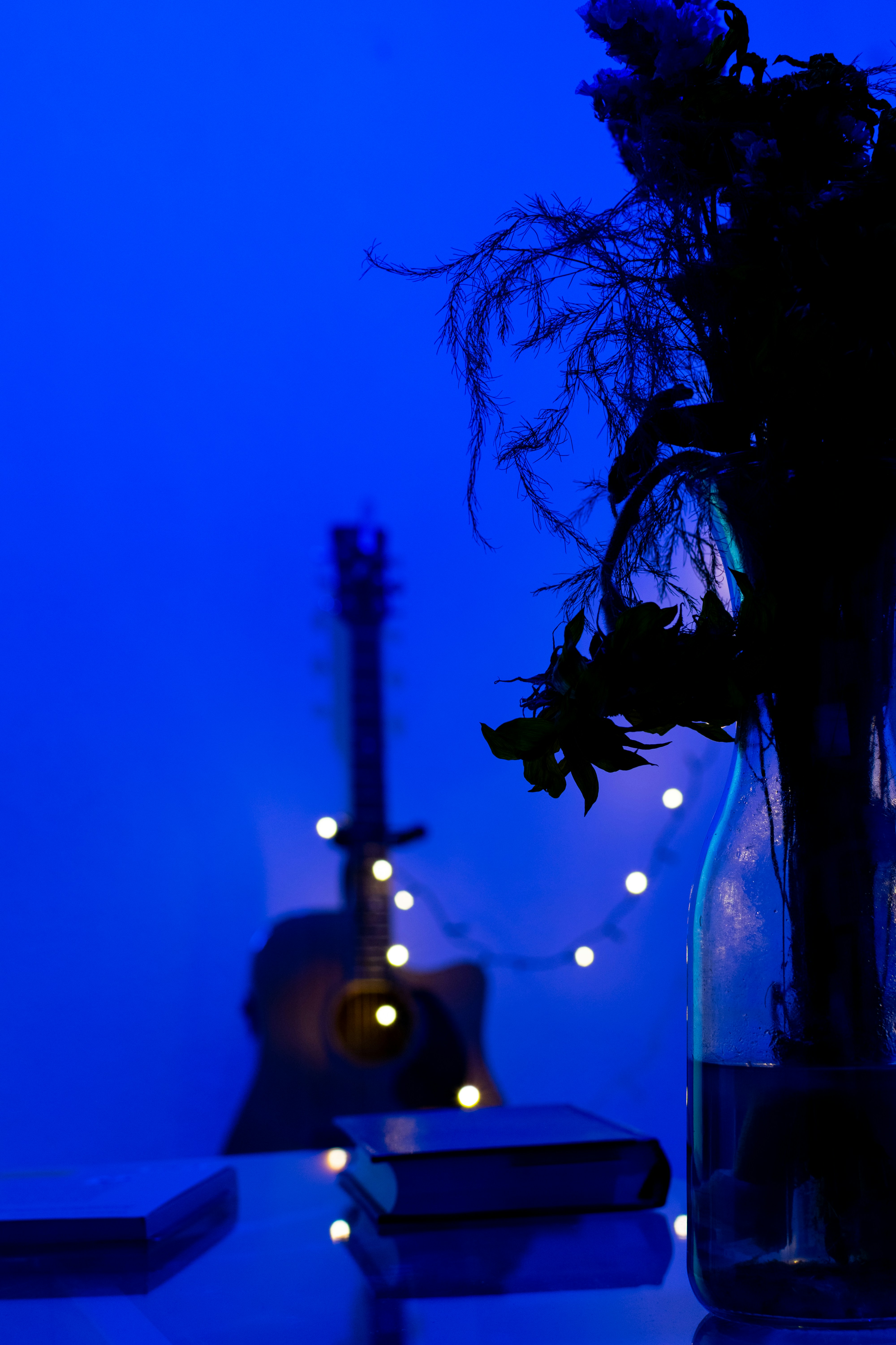 Azure Reverie: Guitar Beneath a String of Fairy Lights