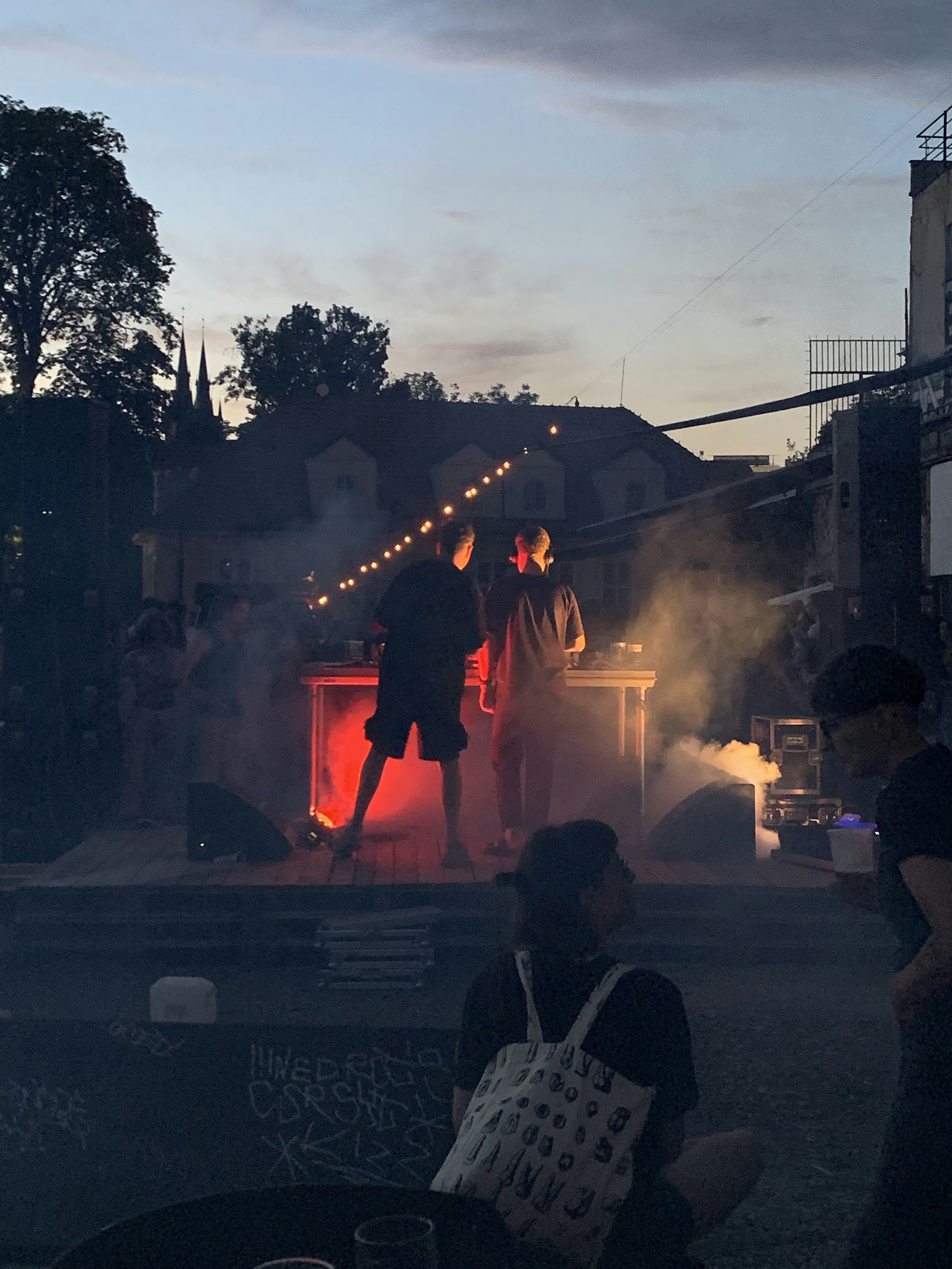Red-glow Reverie: A Dusk Street Stage Alive with Smoke and Light