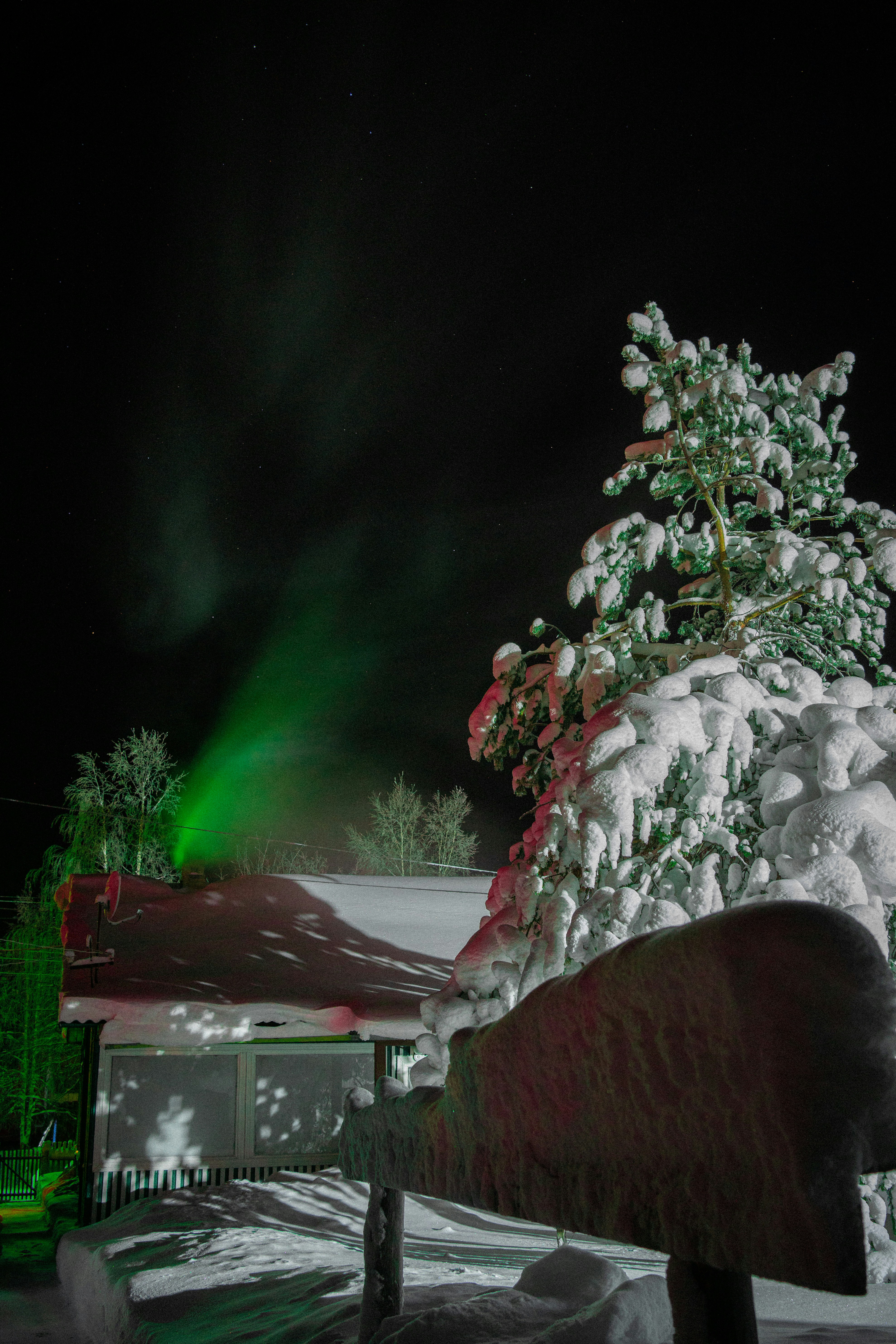 Aurora over a Snowbound Cabin