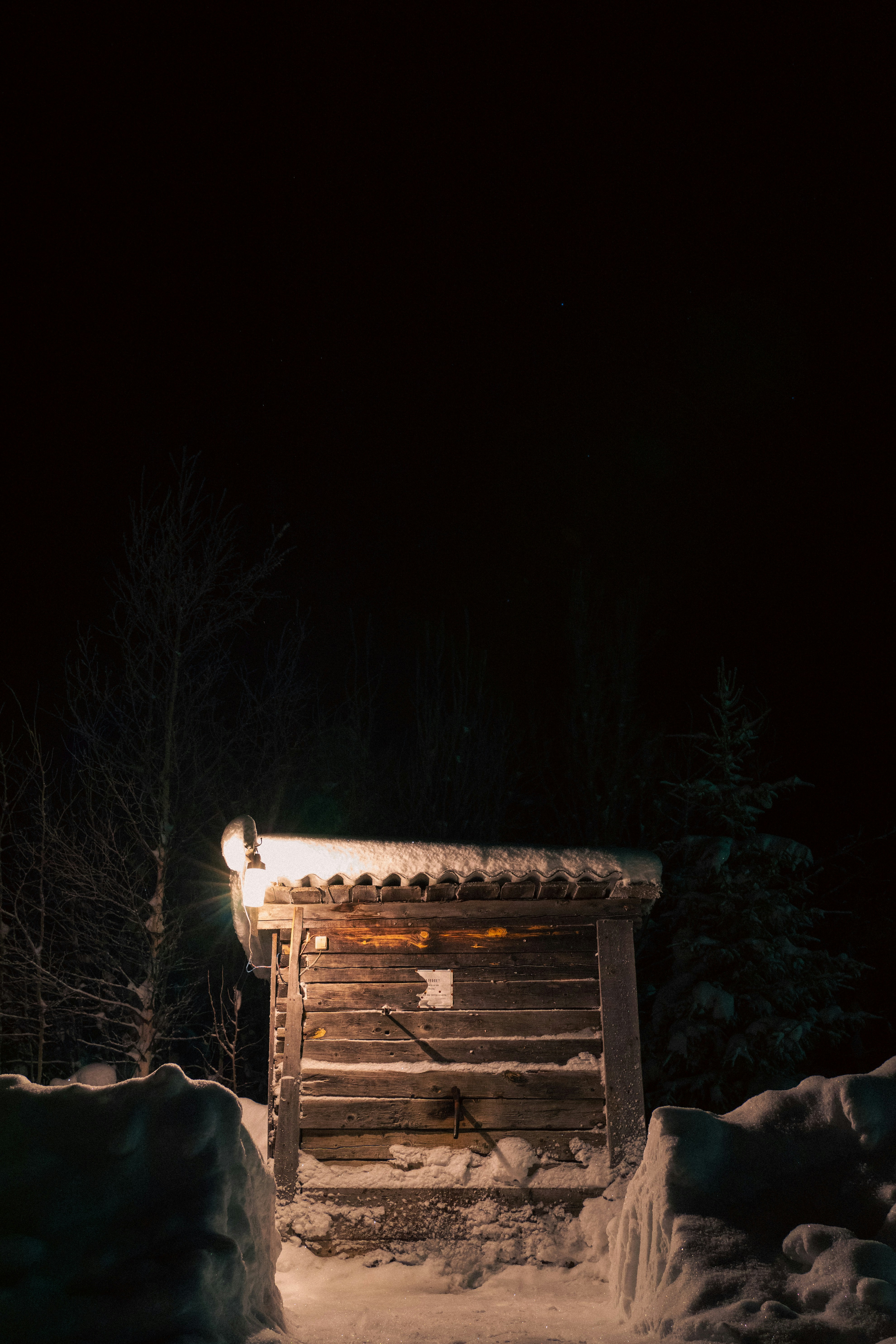 Lantern-Lit Snowbound Shed Under a Velvet Night Sky