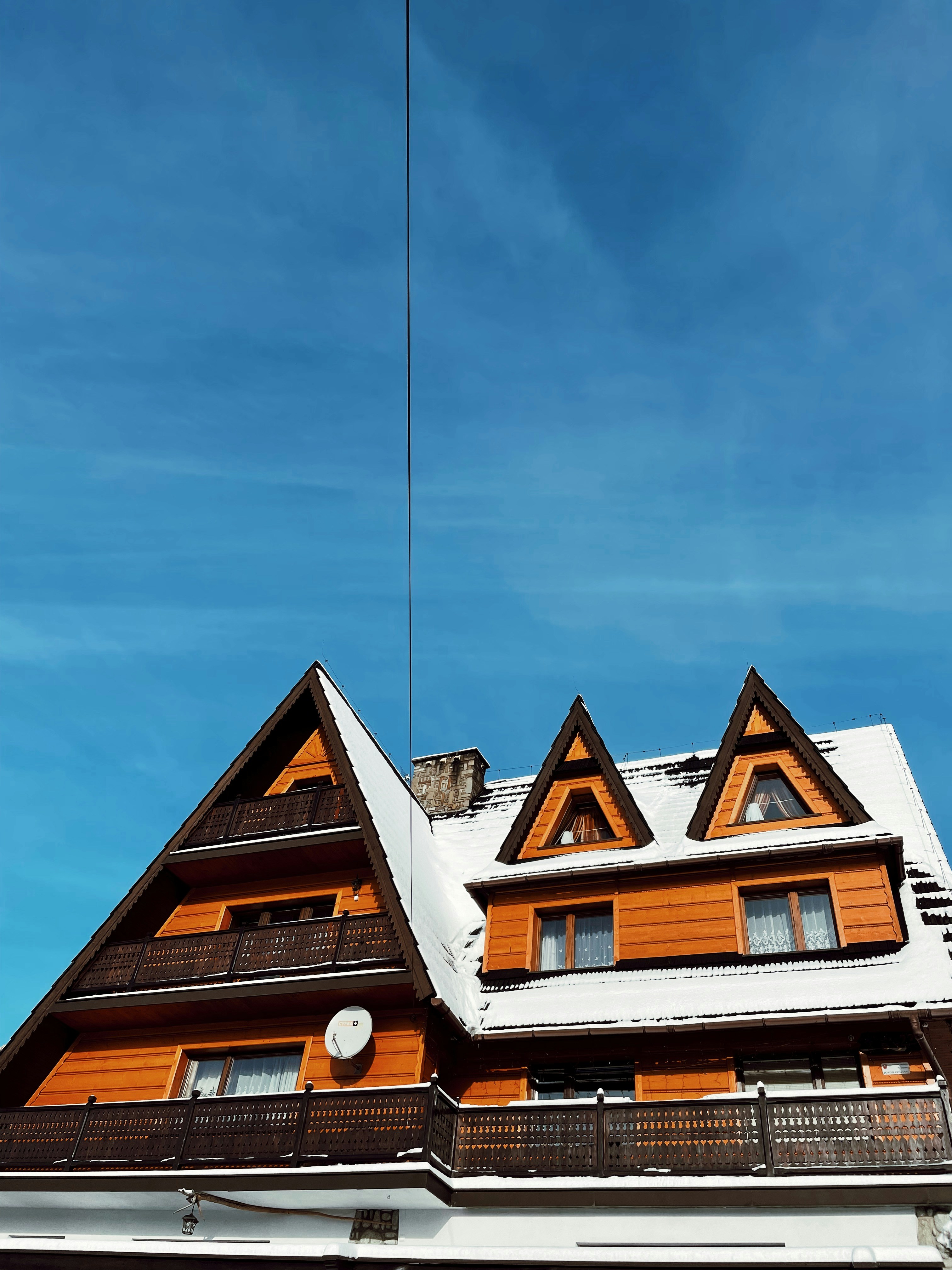 Snow-Capped Chalet Peaks Against a Crisp Blue Sky