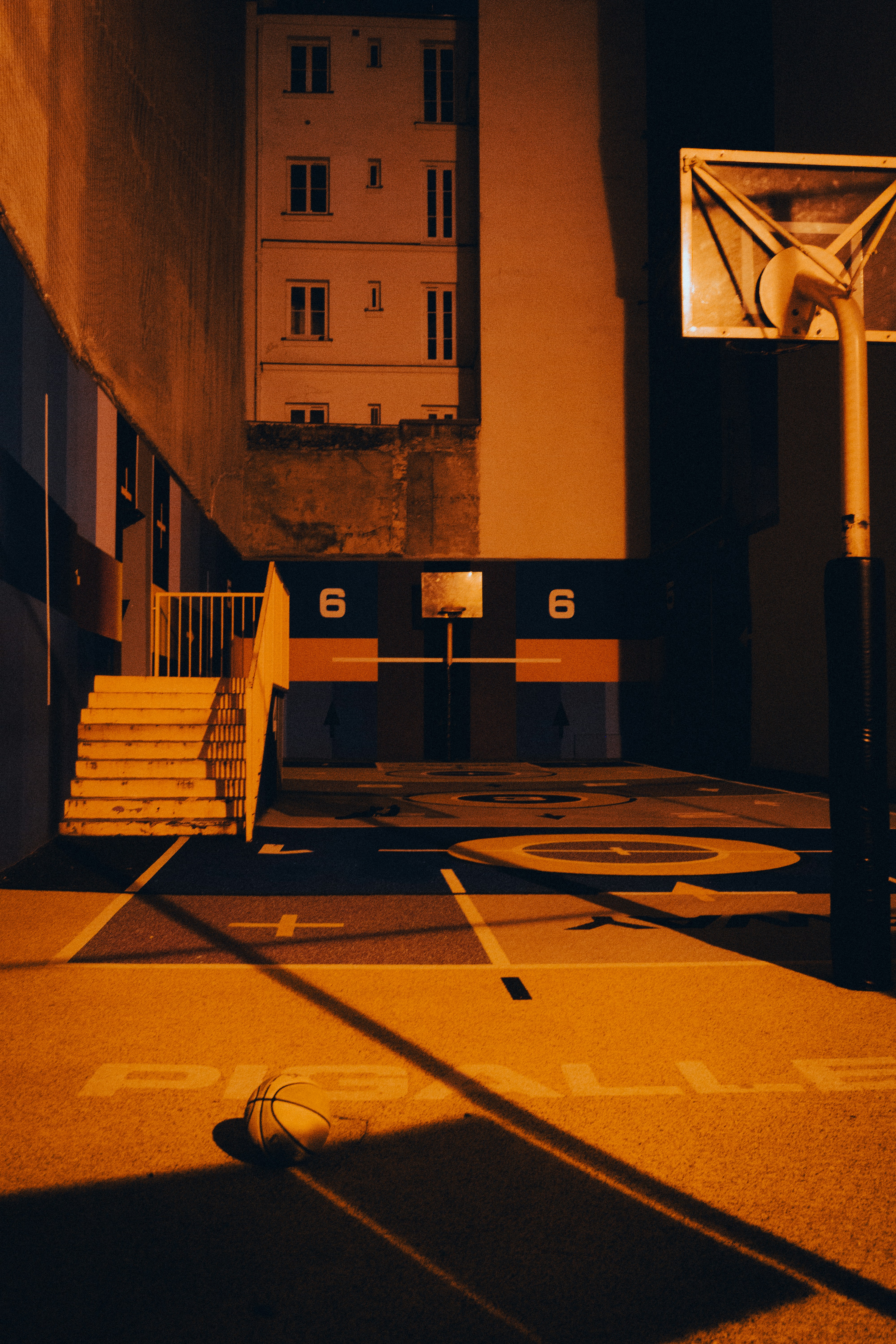 Amber Night Court: A Solitary Urban Basketball Scene