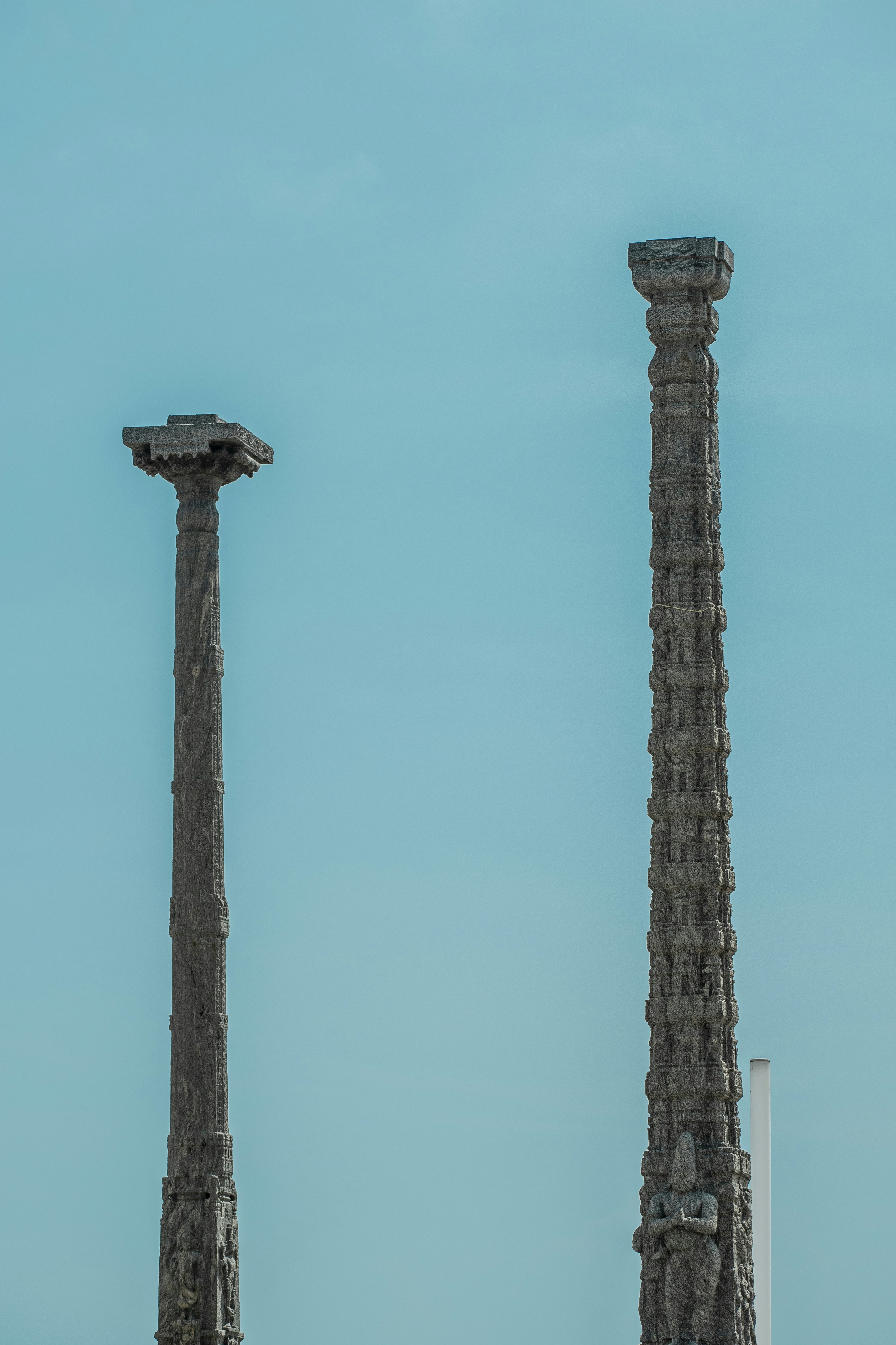 a couple of tall stone pillars sitting next to each other