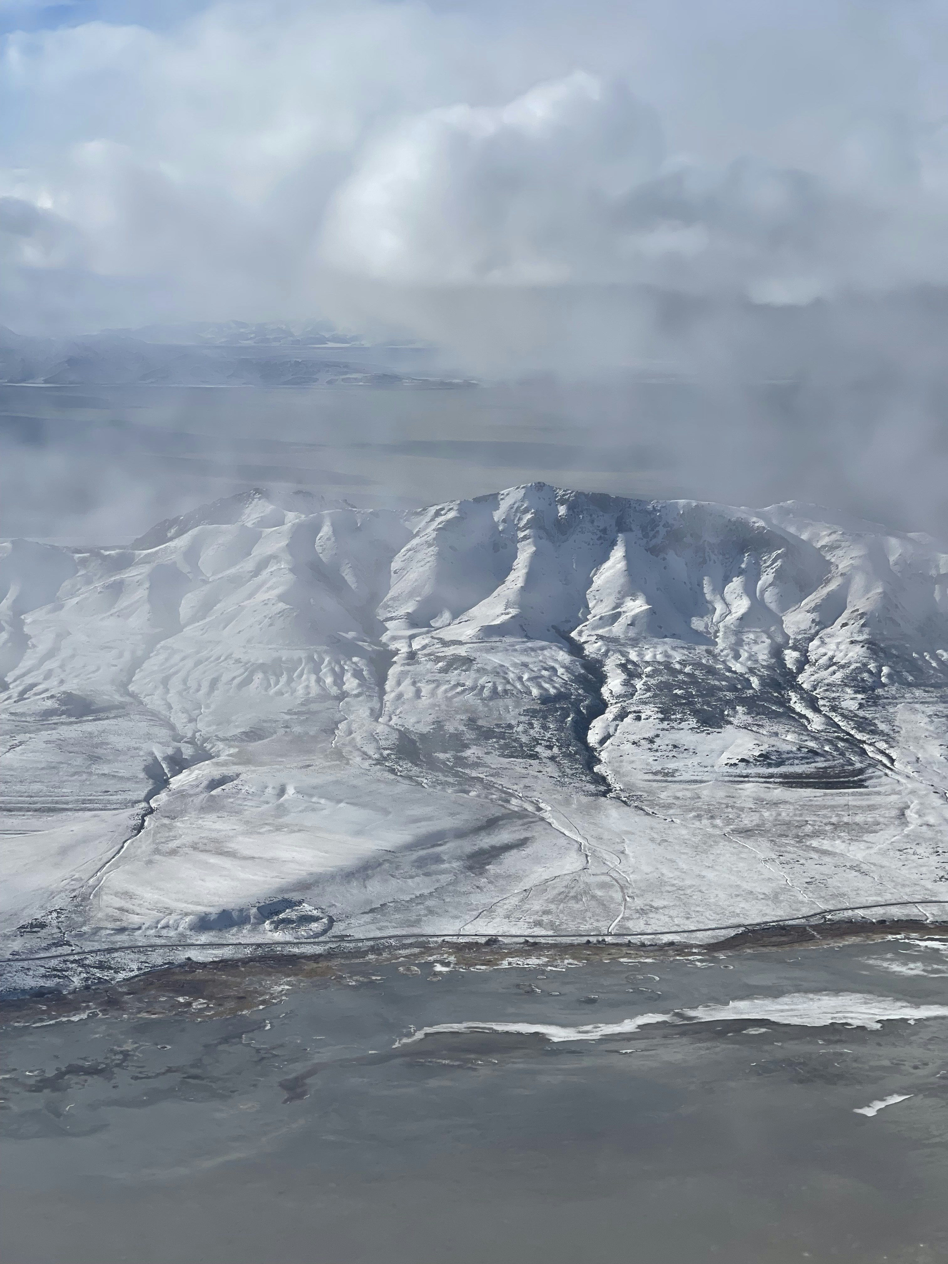 Frozen Crown: Aerial Portrait of Snow-Capped Peaks Framing a Meandering River