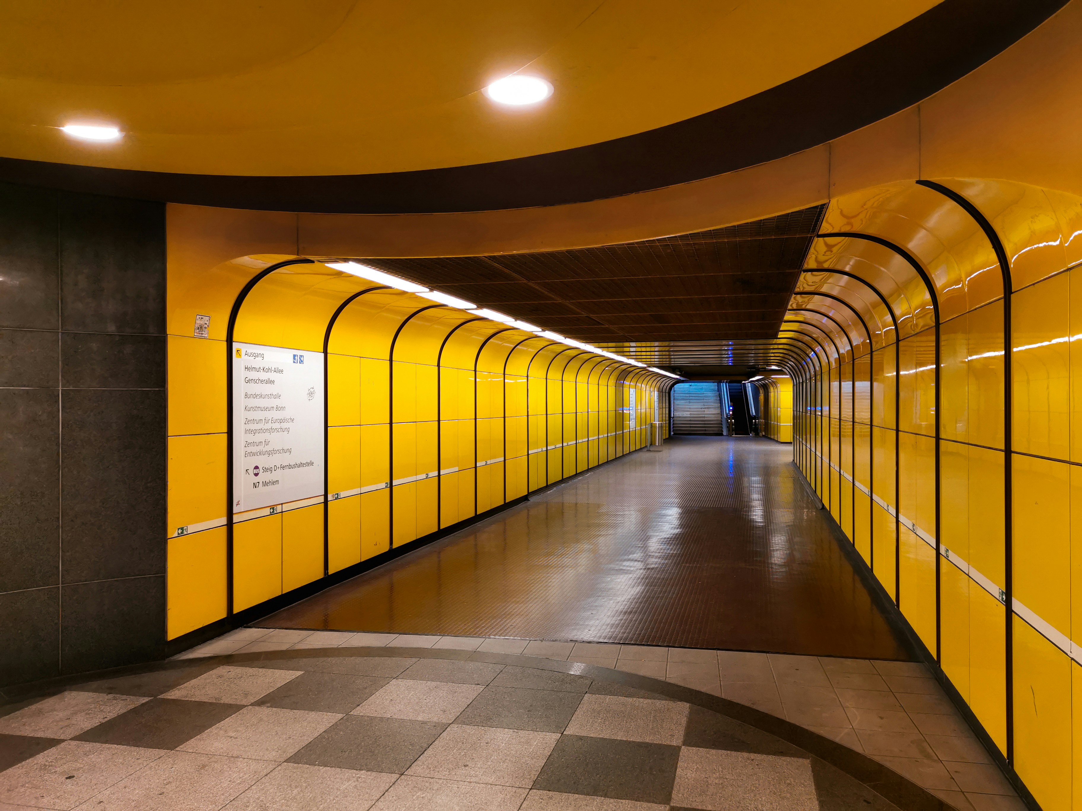 A long yellow tunnel with a checkered floor photo – Free Bonn Image on ...
