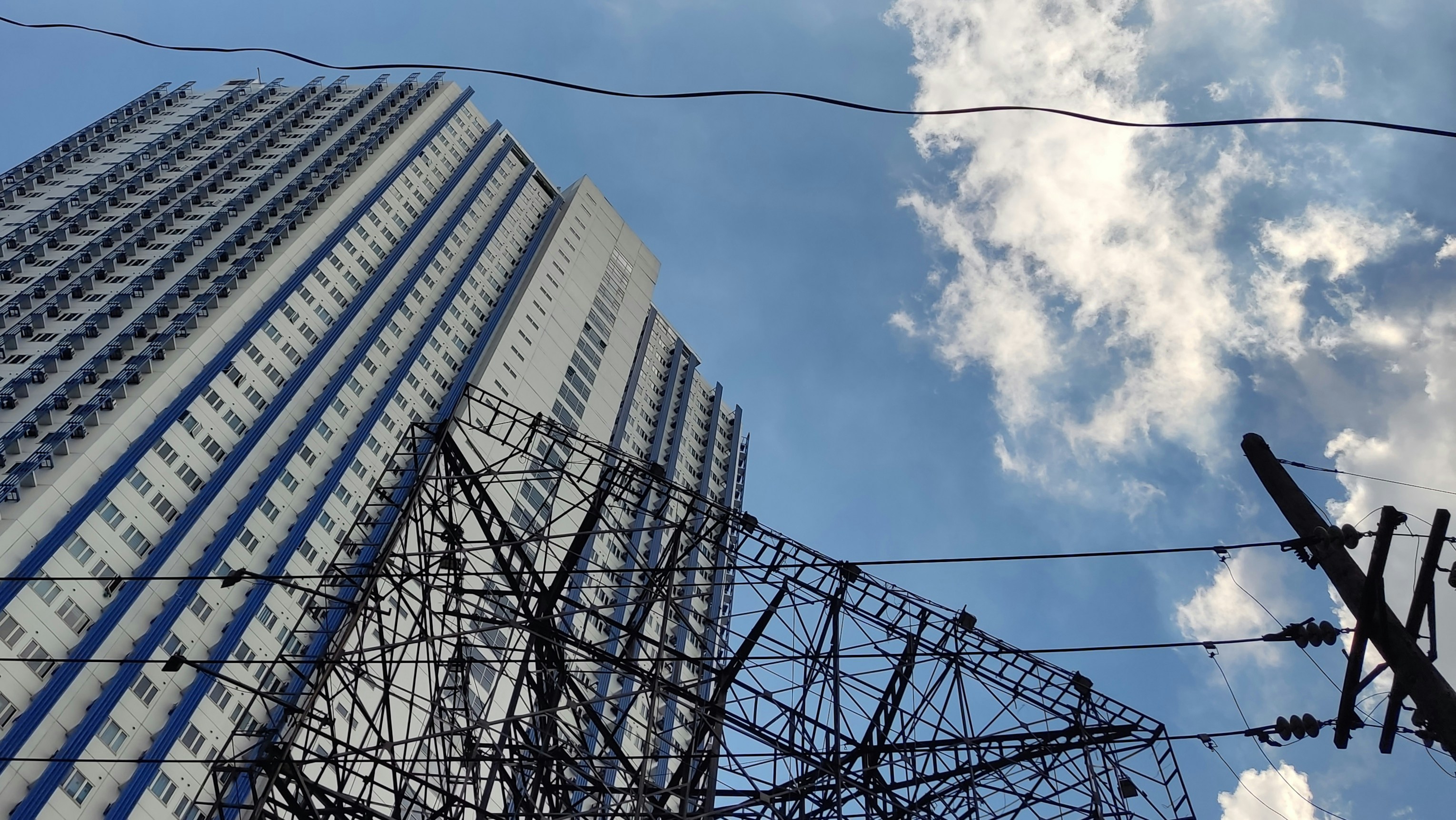 A tall building next to power lines and wires photo – Free Building ...