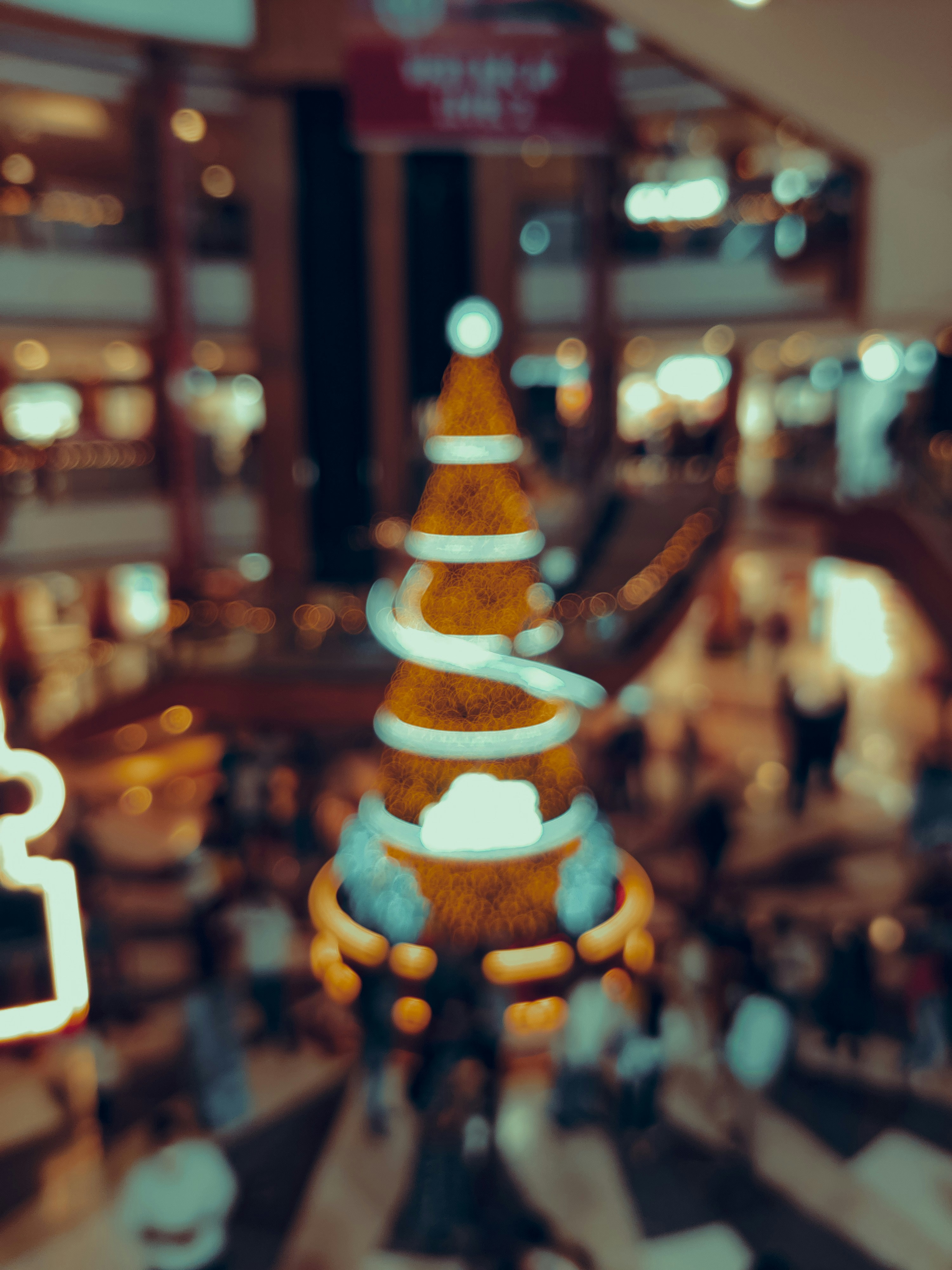 Glowing Carousel in Blur: A Holiday Atrium Under Soft Neon Lights