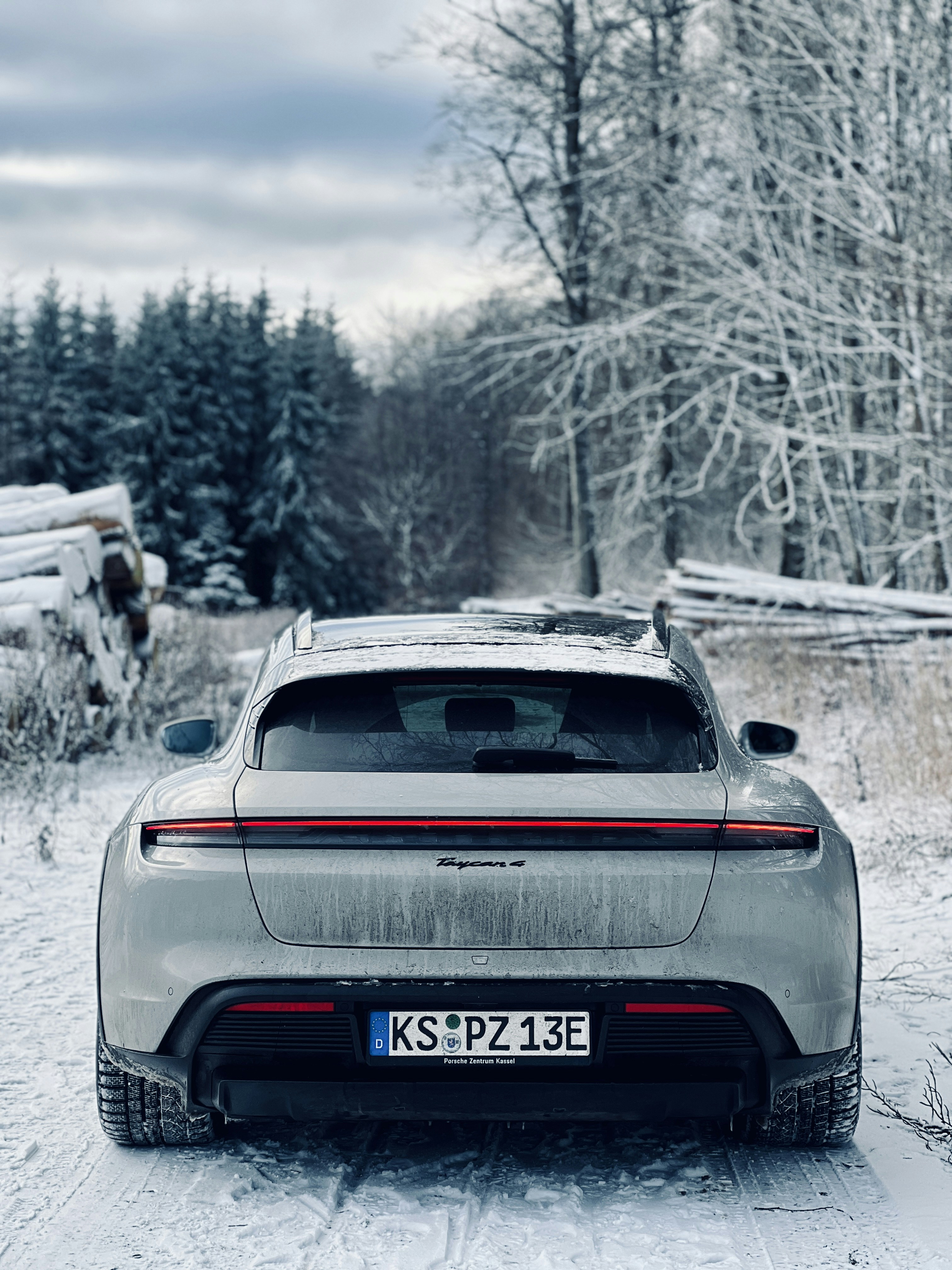 Midwinter rear-drive: a silver Porsche Cayenne S waiting in the snow