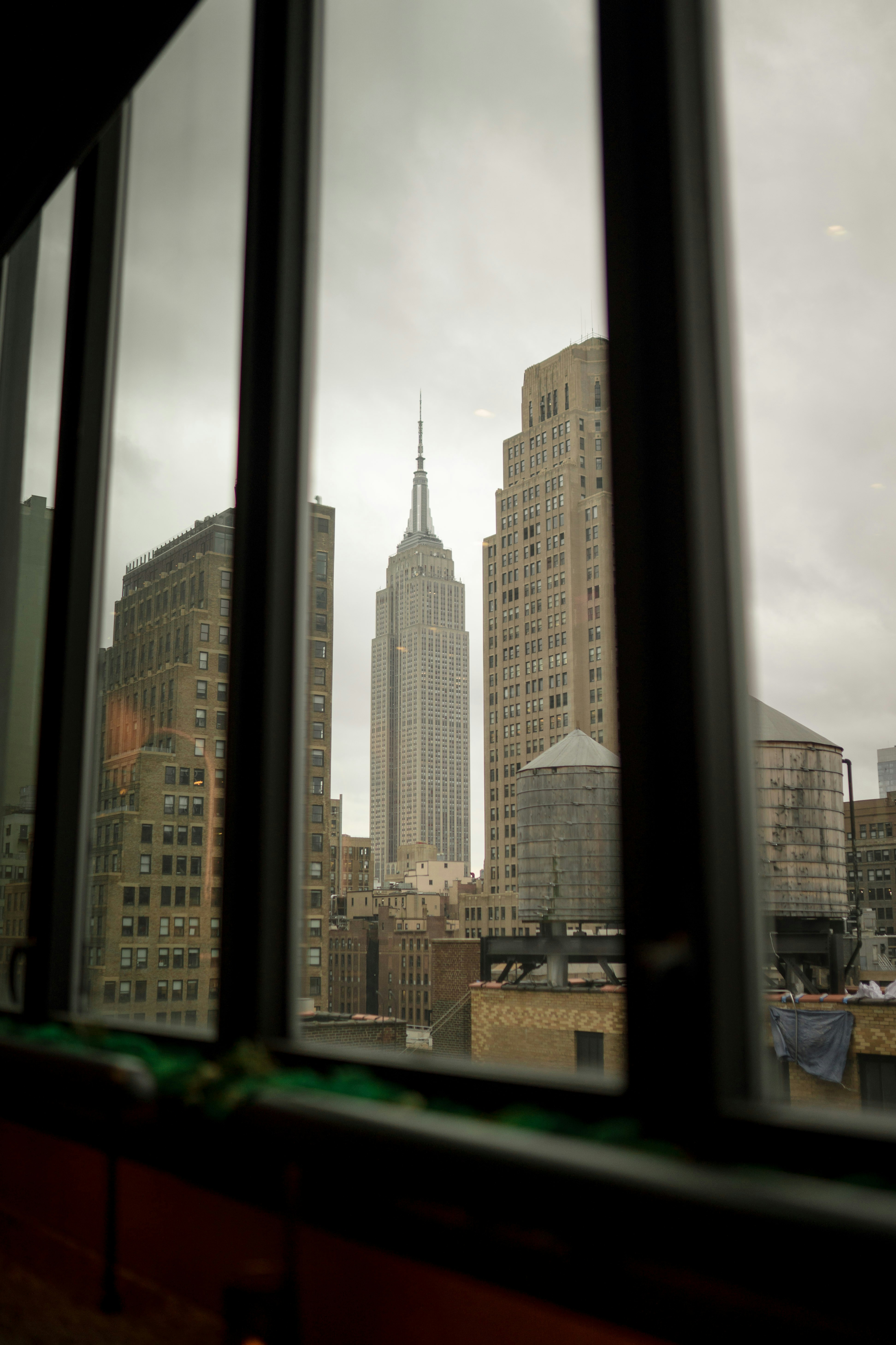 Framed Spire: Empire State Rising Between Window Bars