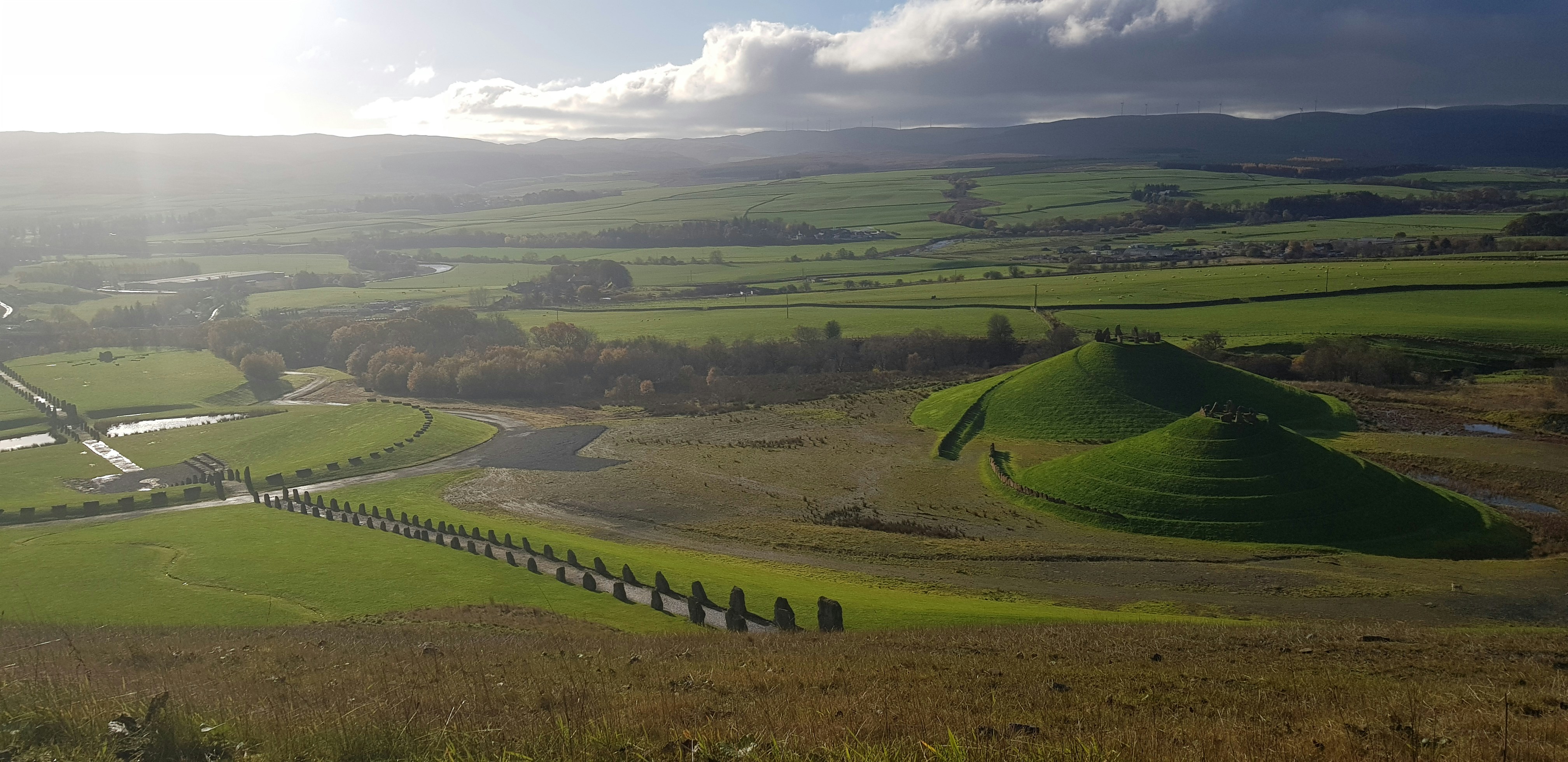 Sunlit Earthen Ramps: A Rolling Hillscape with Terraced mound