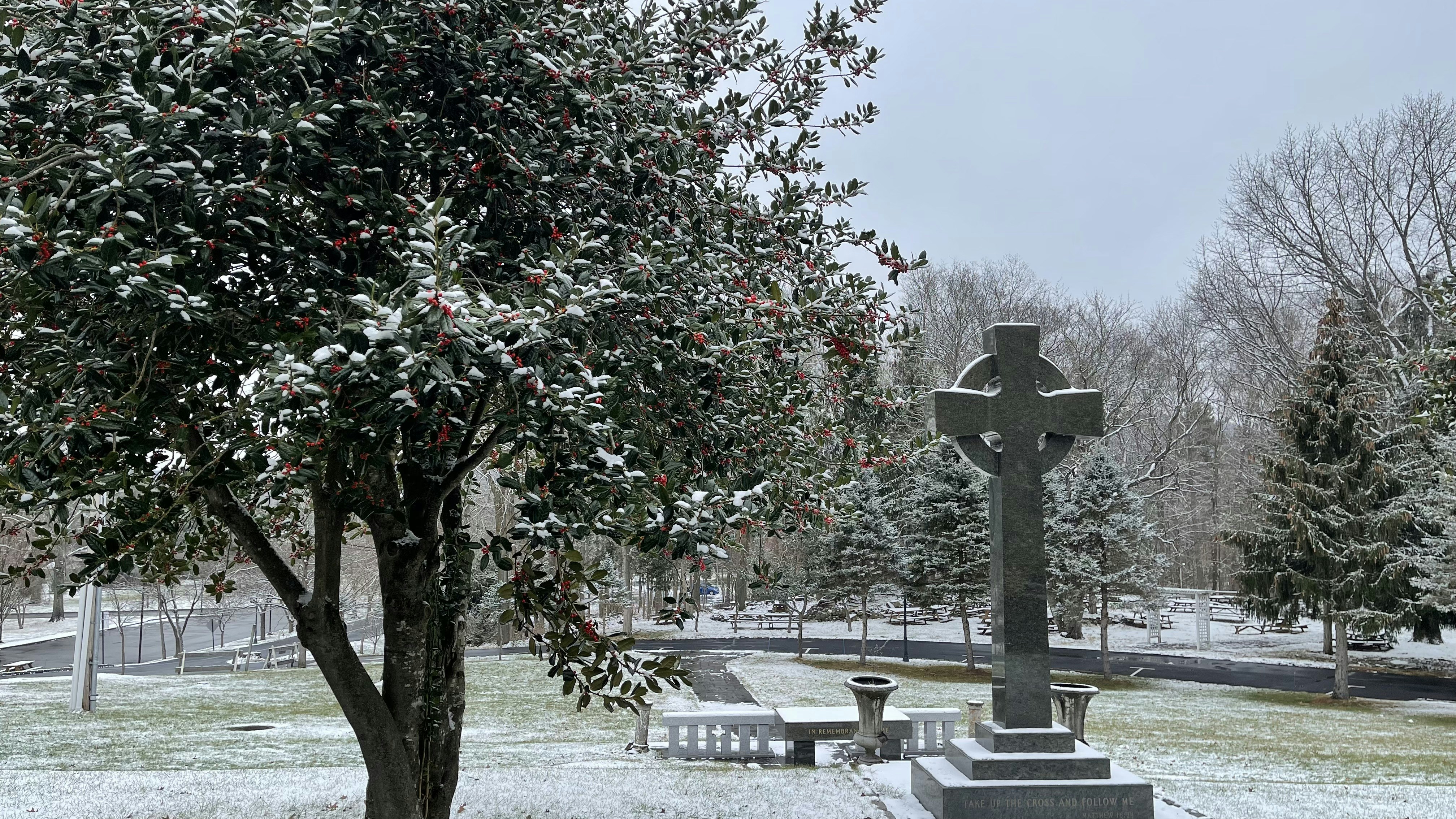 Cross in Winter Silence: A Snow-Kissed Cemetery Scene