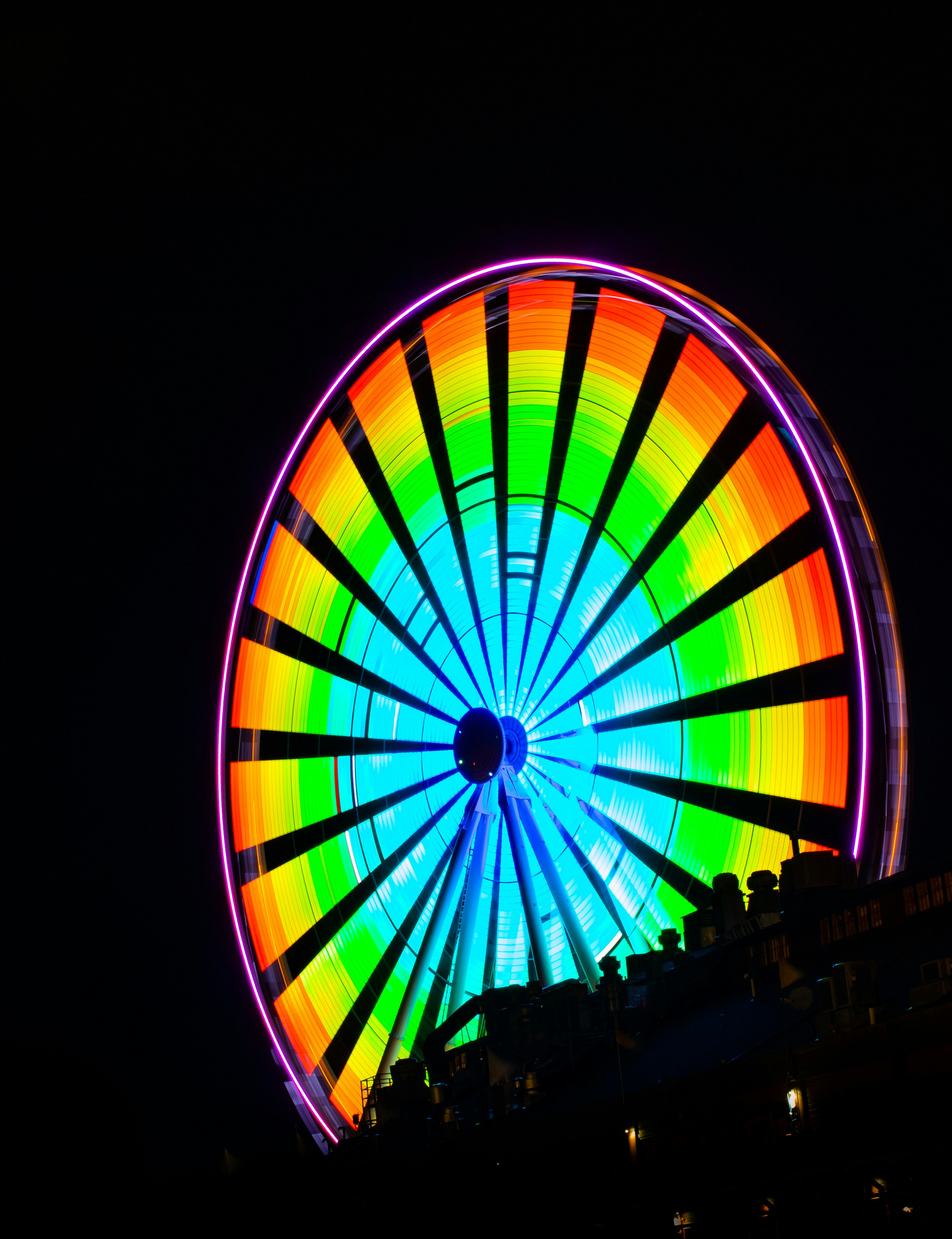 Rainbow Wheel Illumination: Nighttime Ferris Spectacle