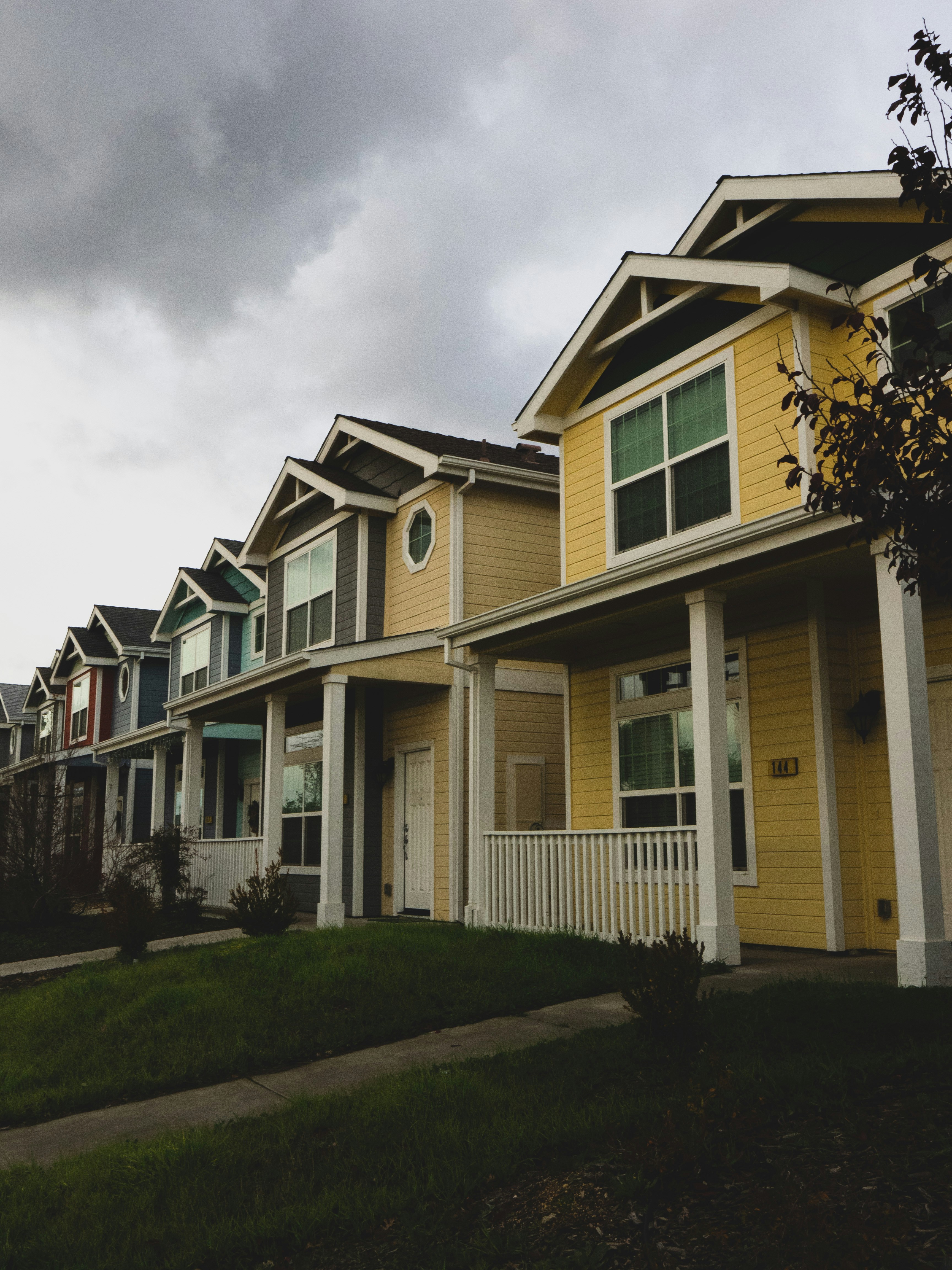 Colored Townhomes Lineup Under Stormy Skies