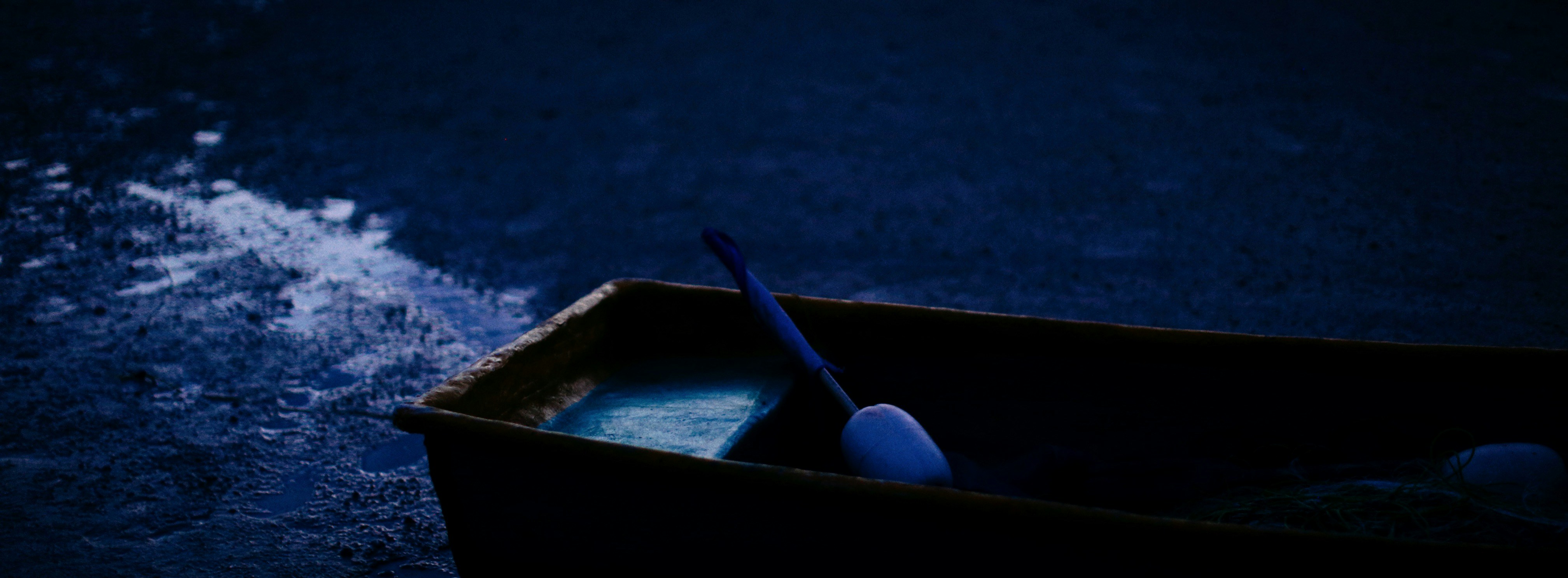 Midnight Row: A Quiet Echo of Blue in a Boat