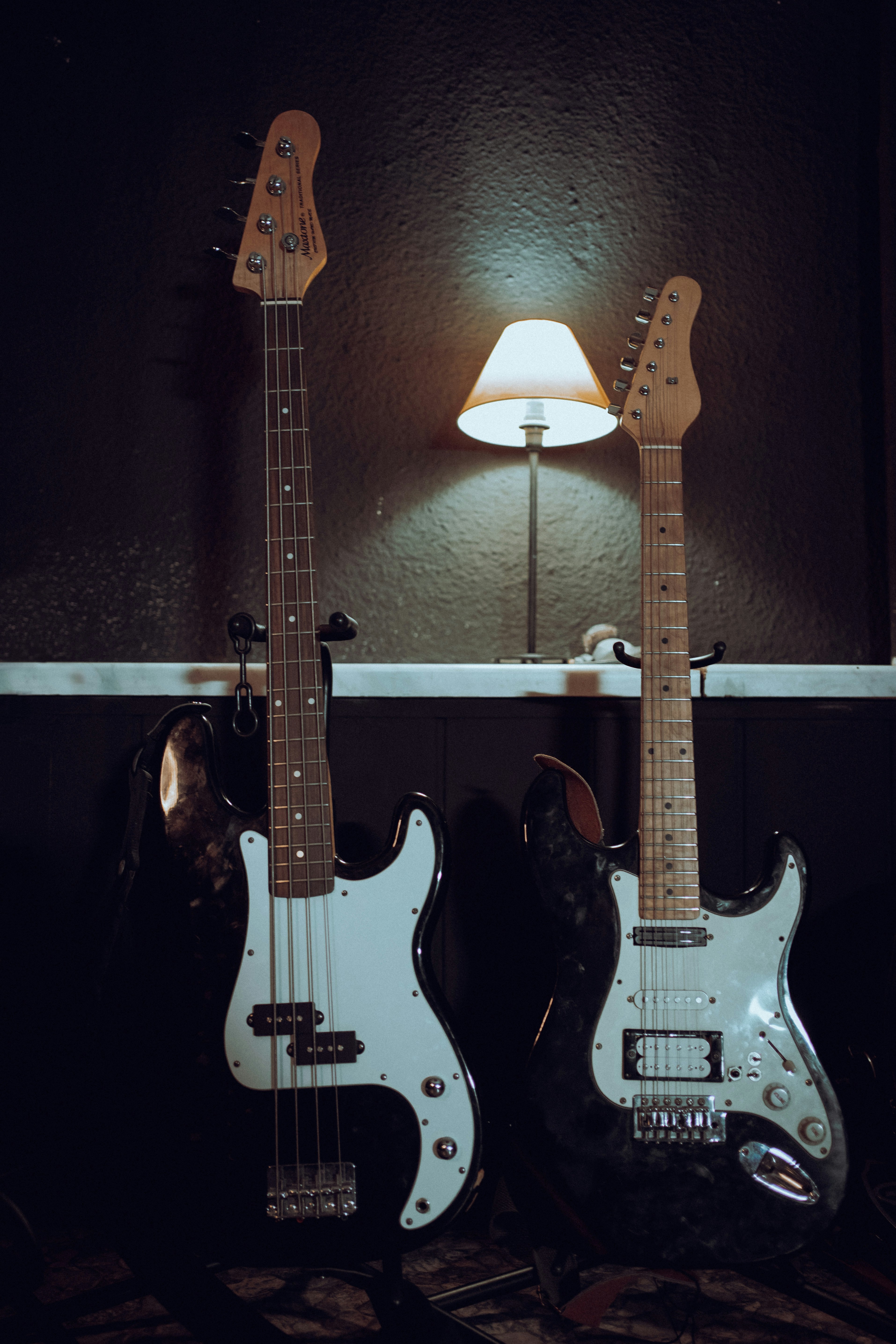 Two Guitars in a Dim Studio with a Warm Lamp