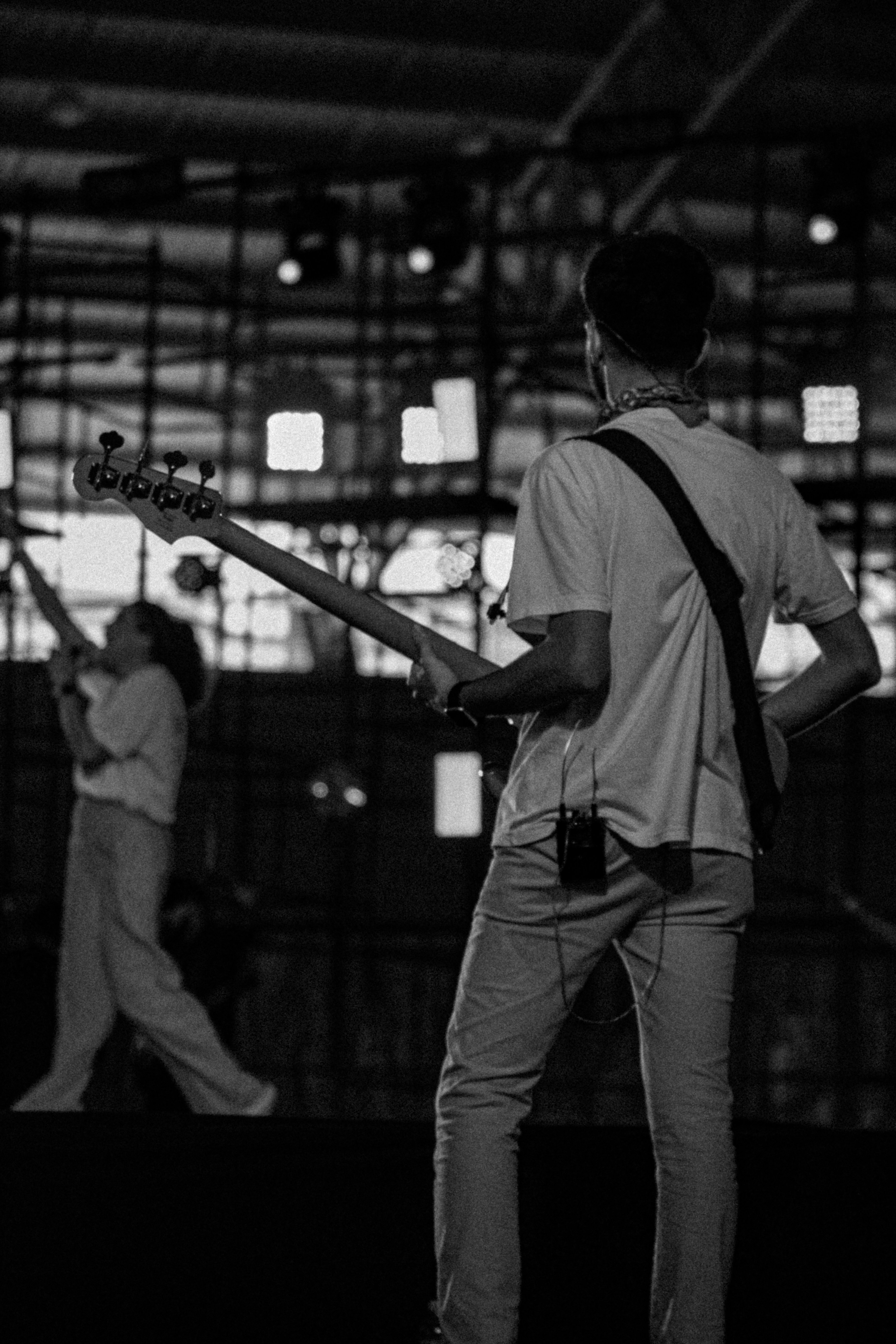 a black and white photo of a man playing a guitar
