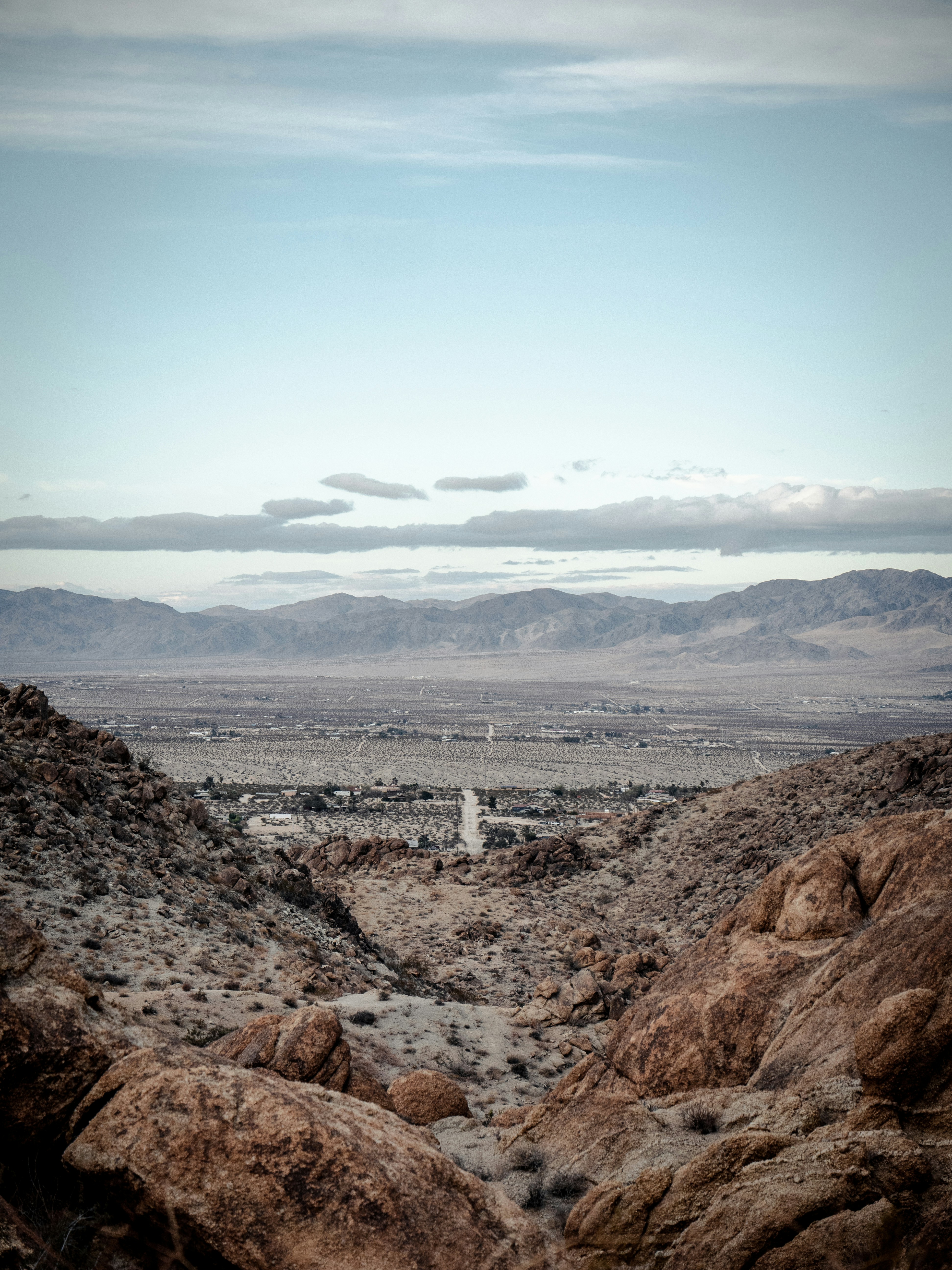 Stone Foreground, Silent Valley: A Desert Horizon Unfolds