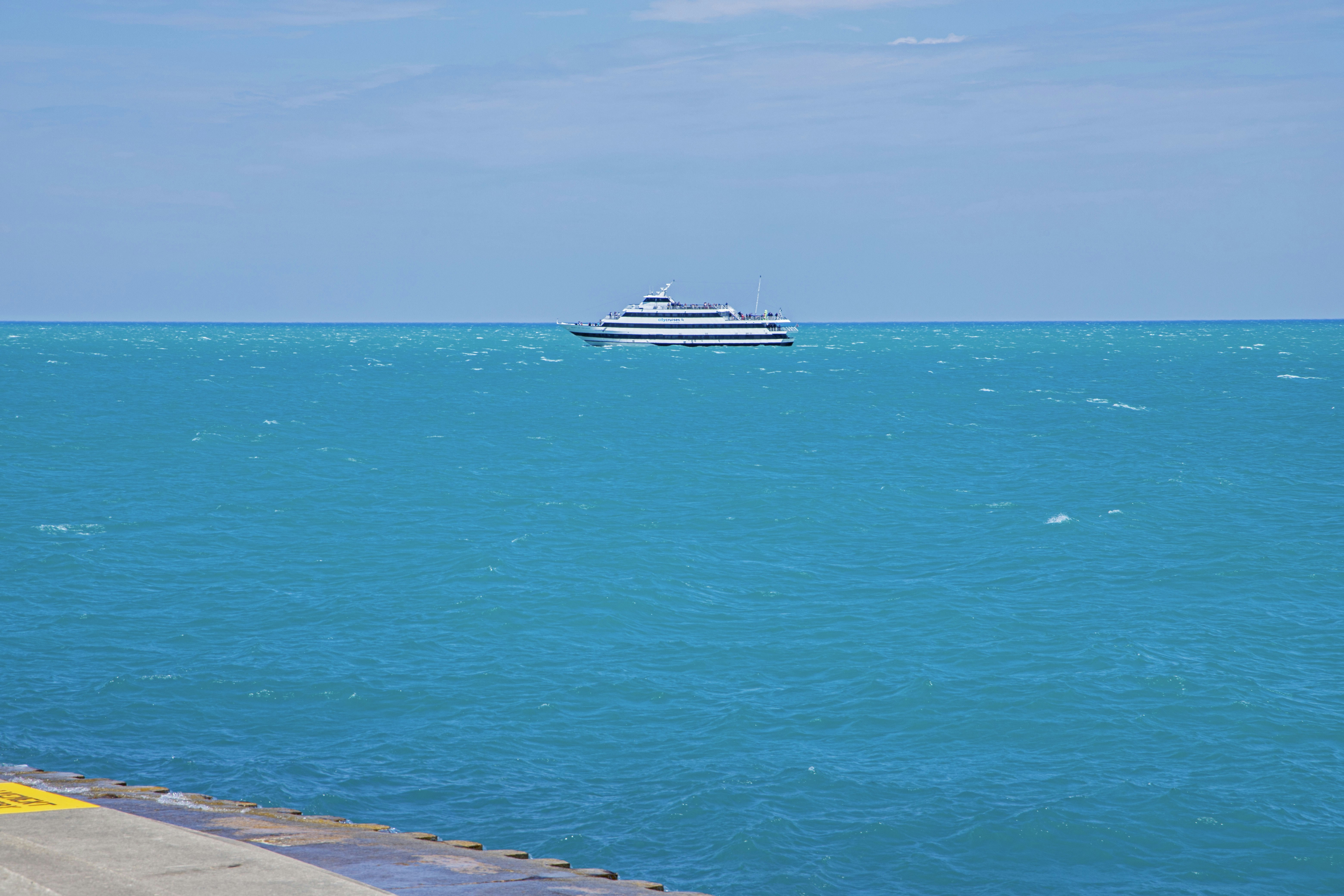 Azure Quiet: A Modern Yacht Rests on a Turquoise Sea