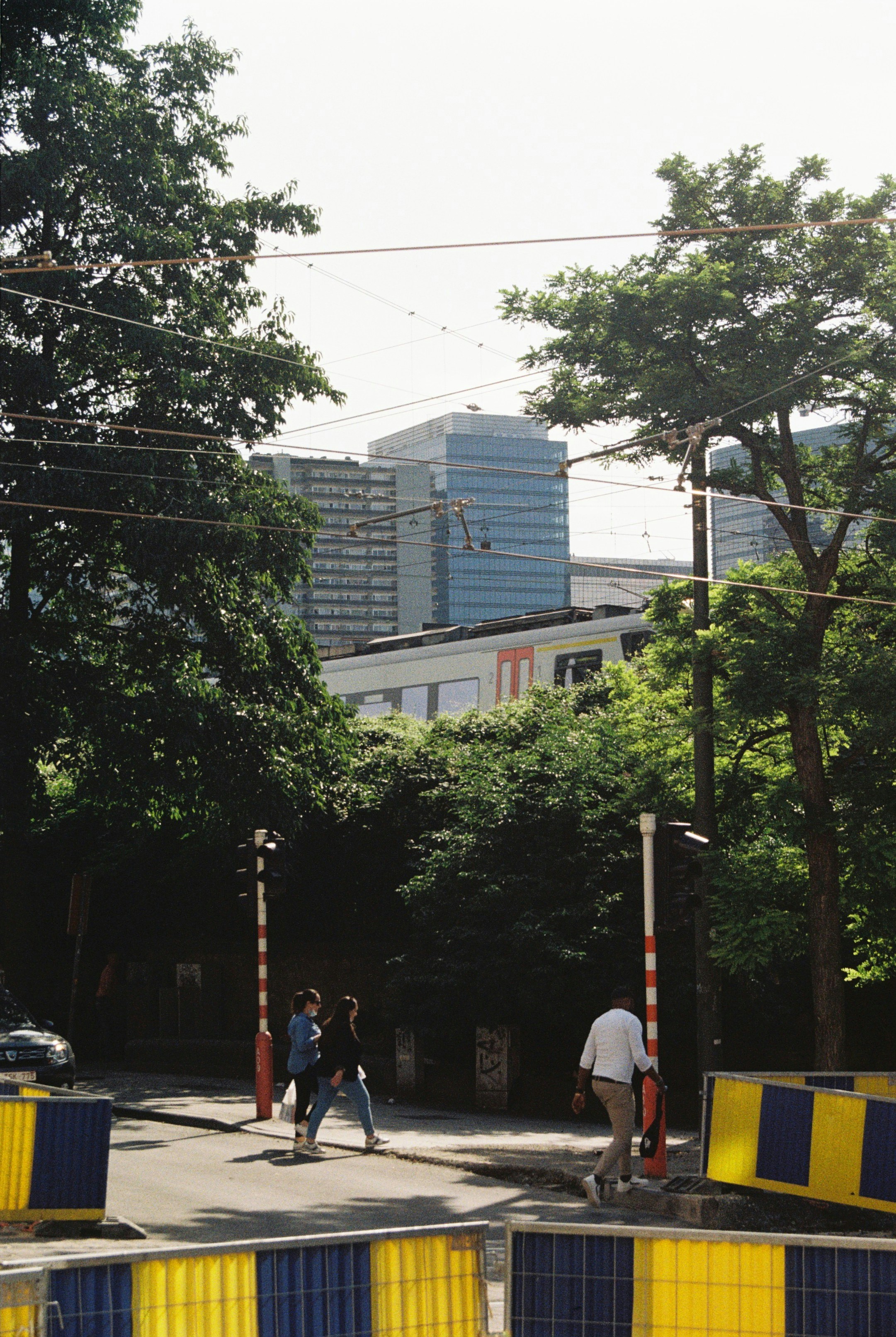 Crossing Under Wires: Pedestrians, Barriers, and Glass Towers