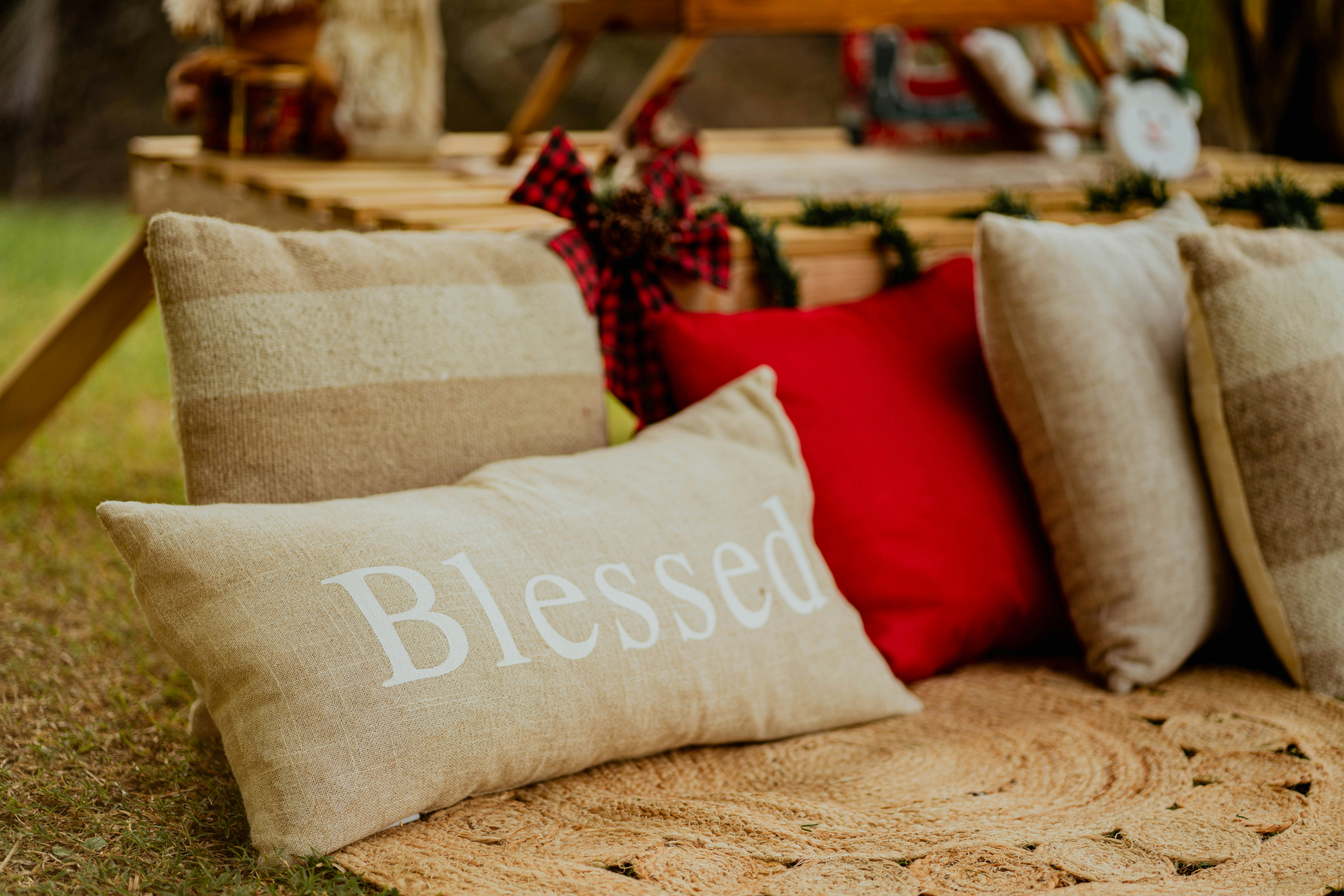A pile of pillows sitting on top of a rug photo – Free Cushion Image on ...