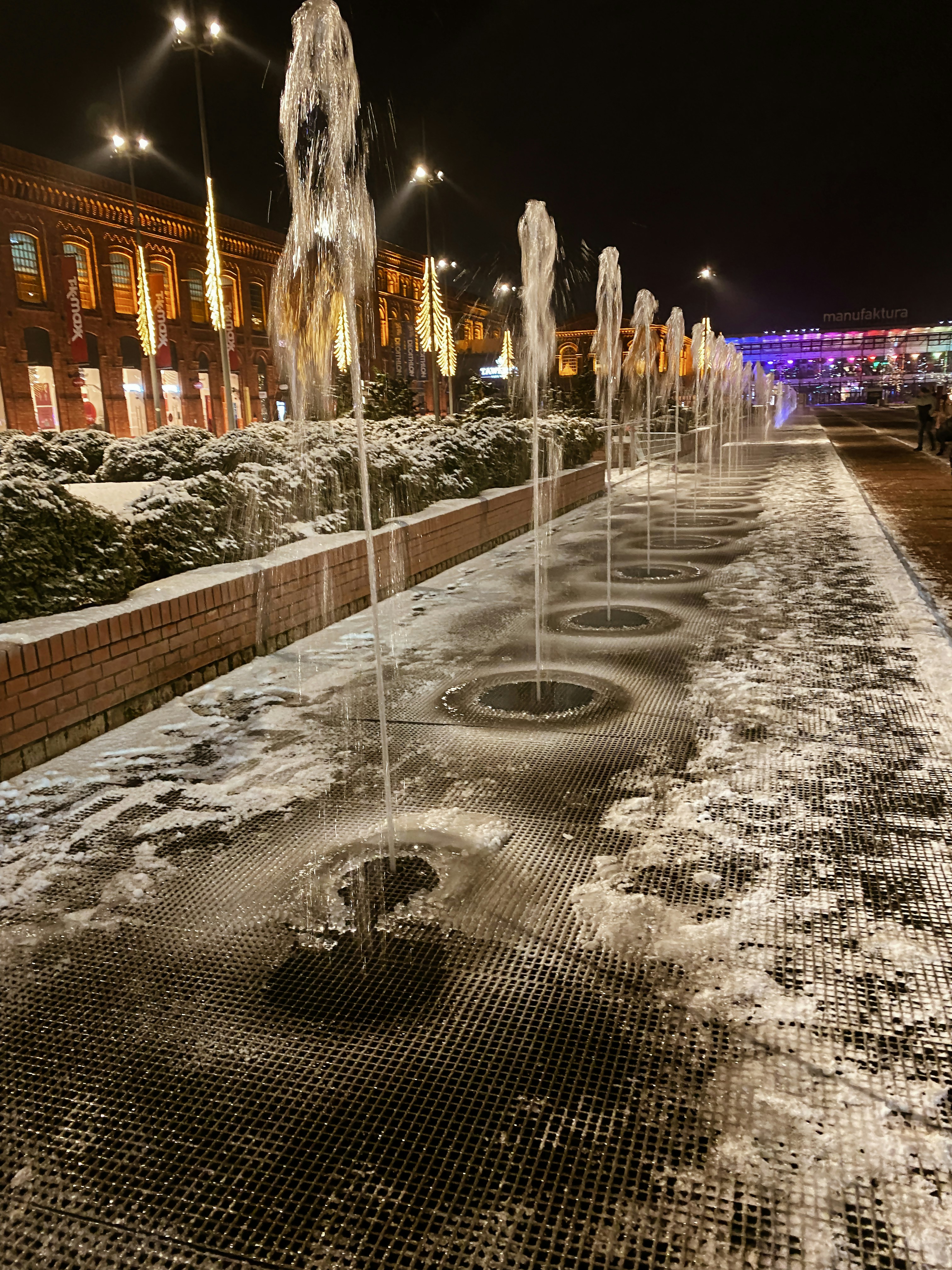 A row of water fountains in front of a building photo – Free ...