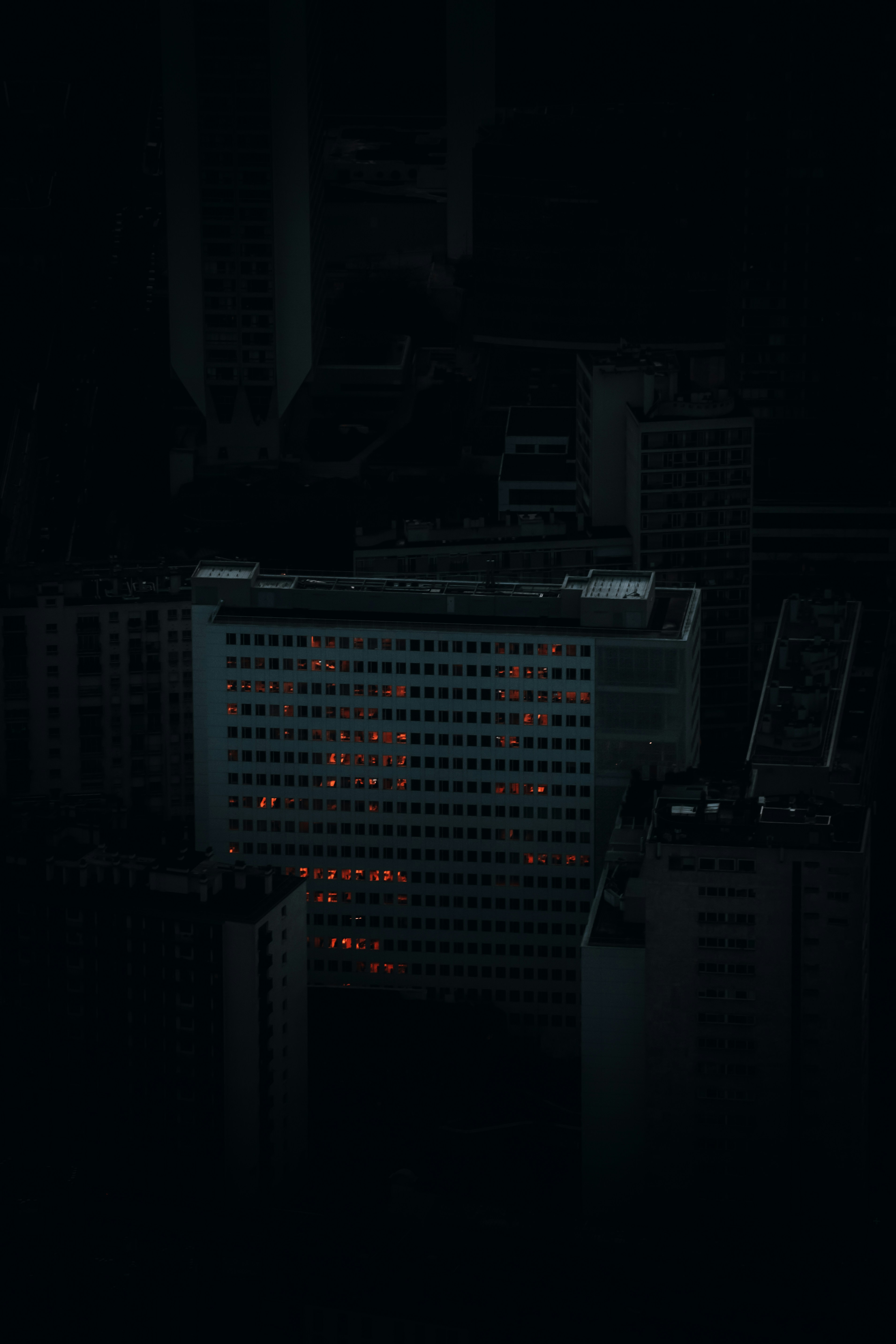 A building with a red light on it in the dark photo – Free Paris Image ...