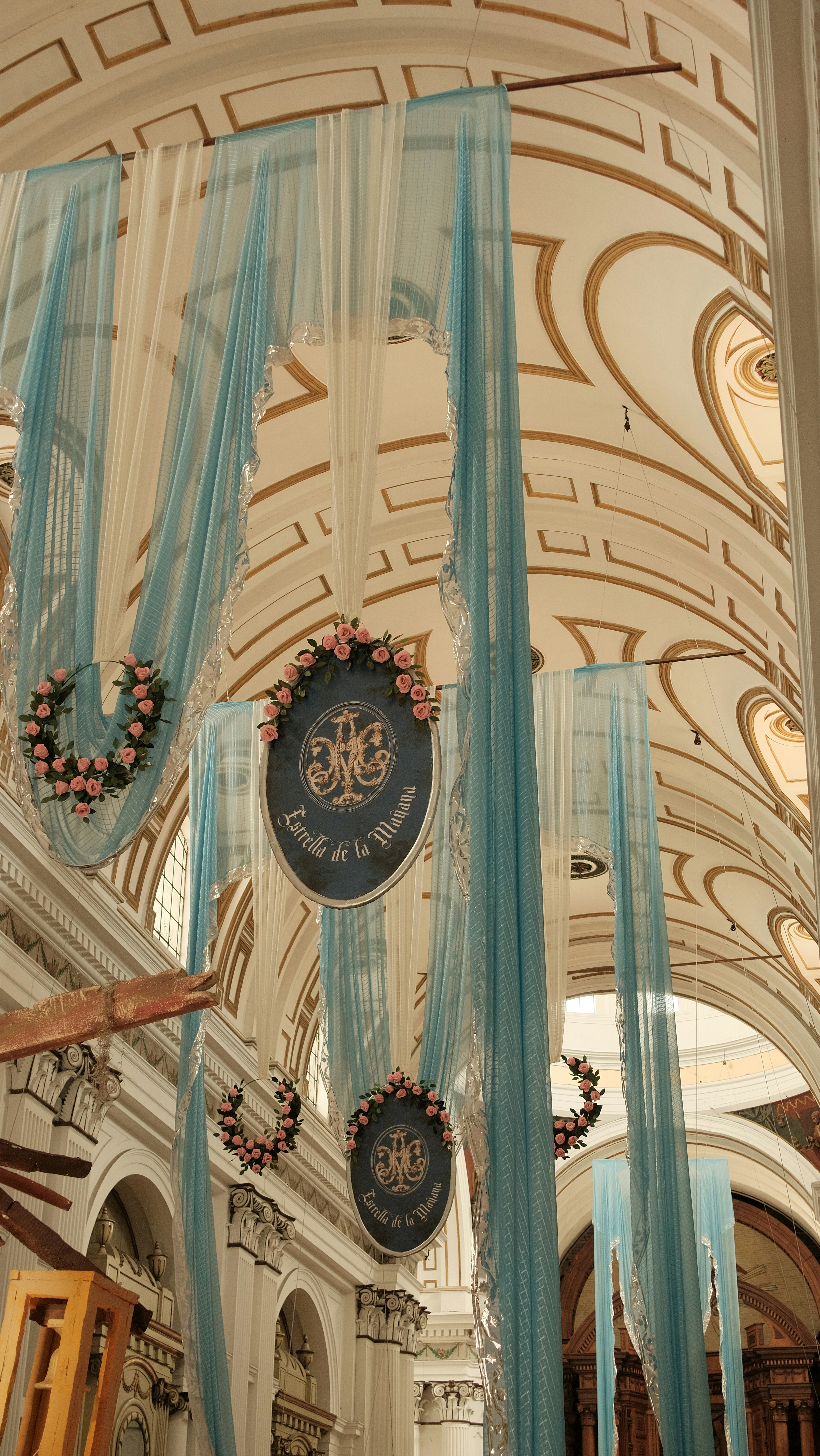 Turquoise Veils Framing a Floral Monogram in an Arching Hall