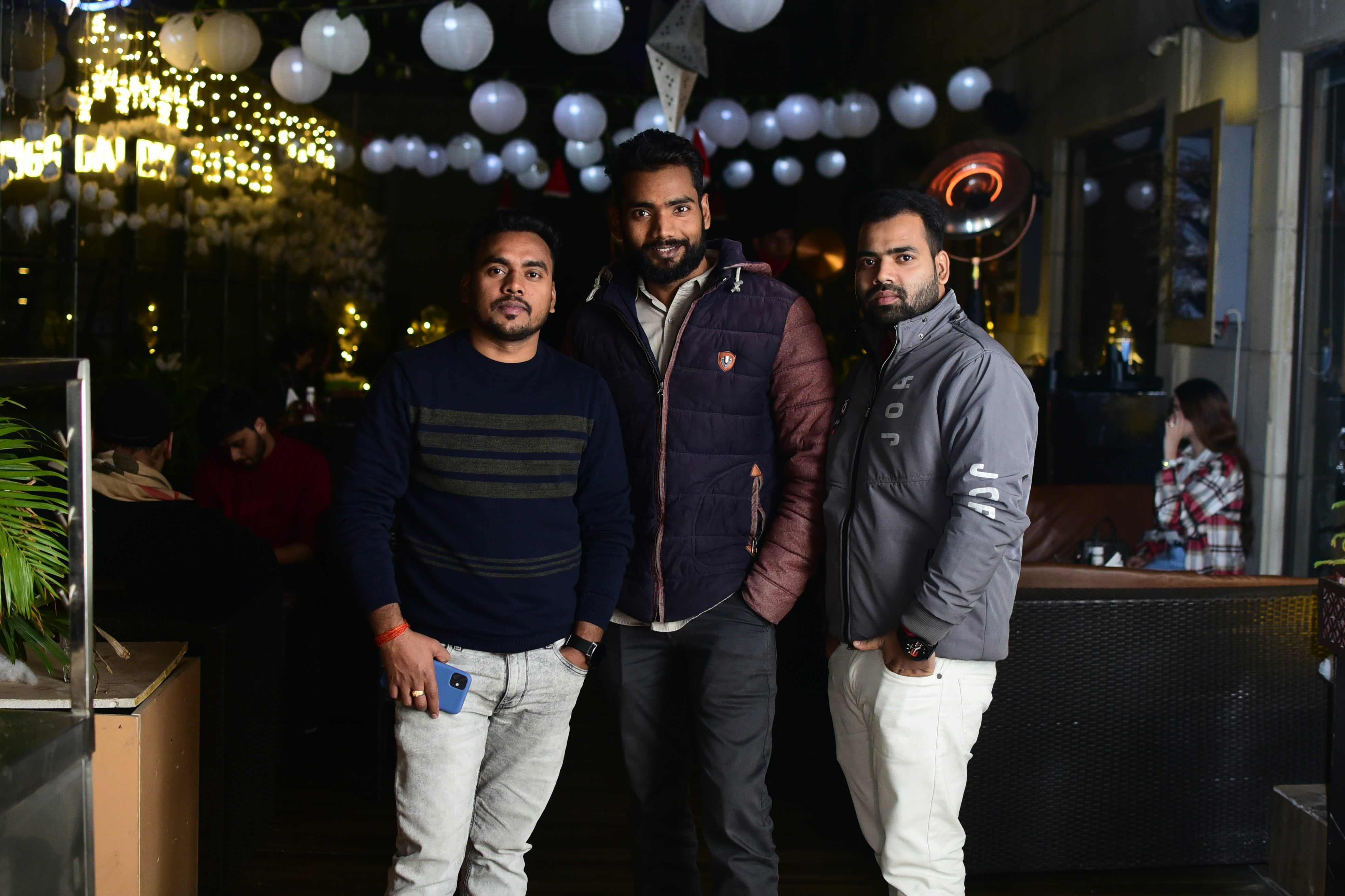 A group of three men standing next to each other photo – Free Black ...