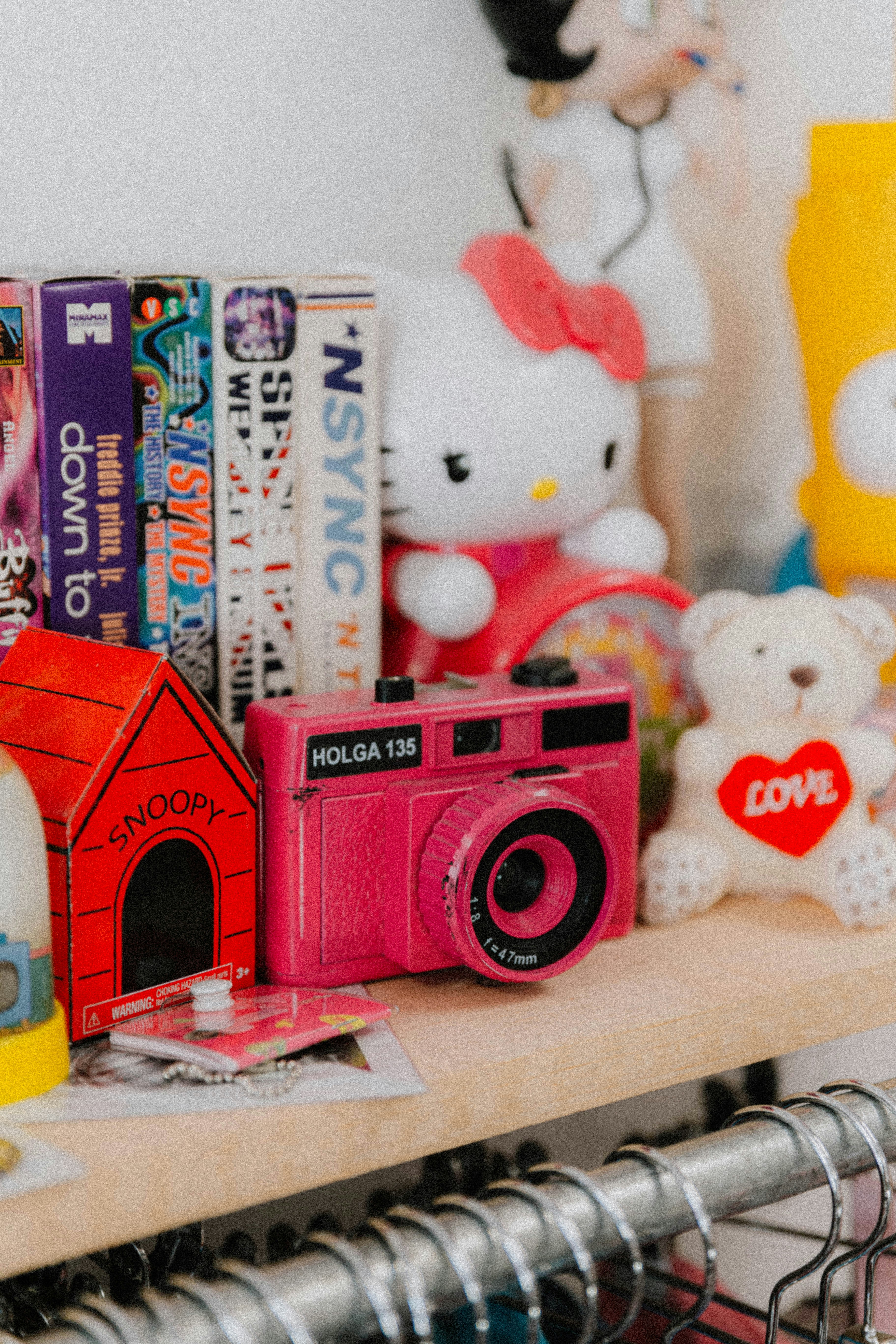 Playful Pink Holga Portrait on a Toy-Shelf Parade