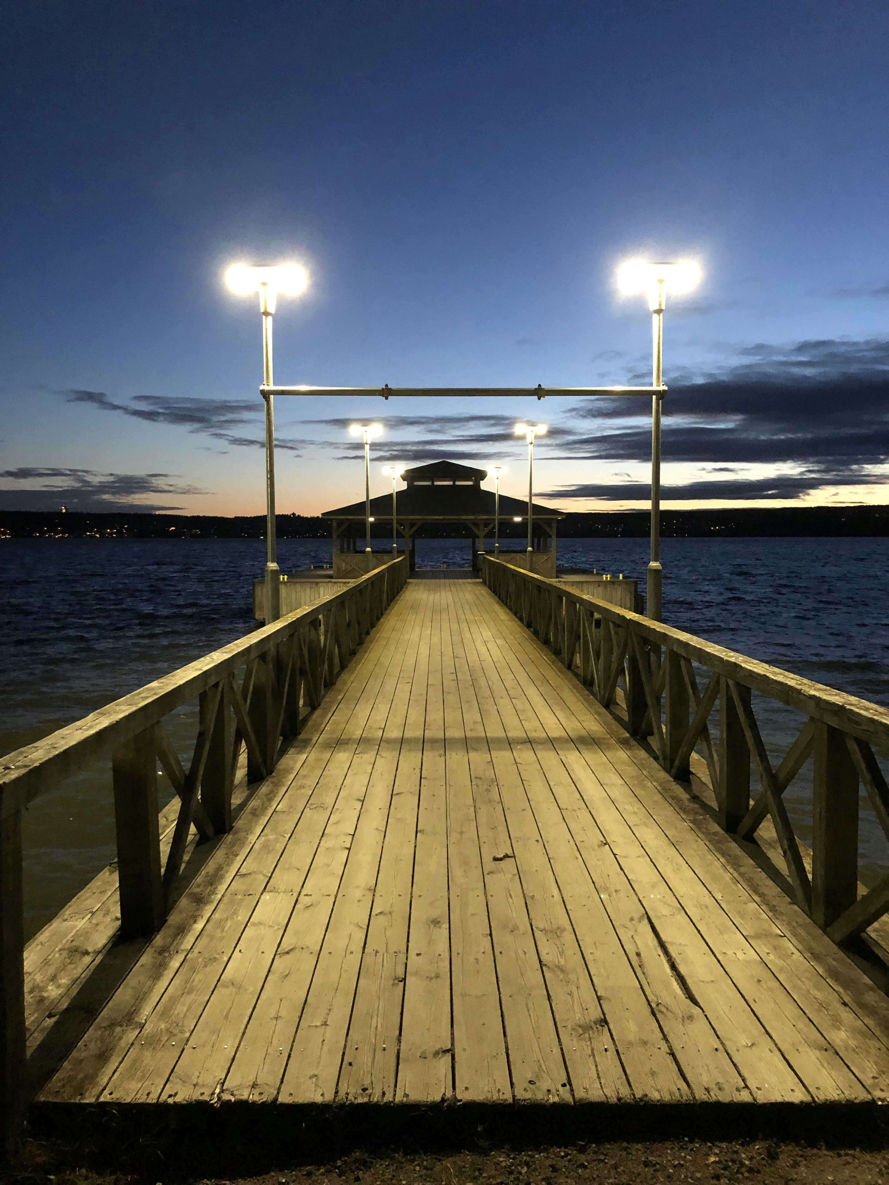A wooden pier with lights on it at night photo – Free Lahti Image on ...