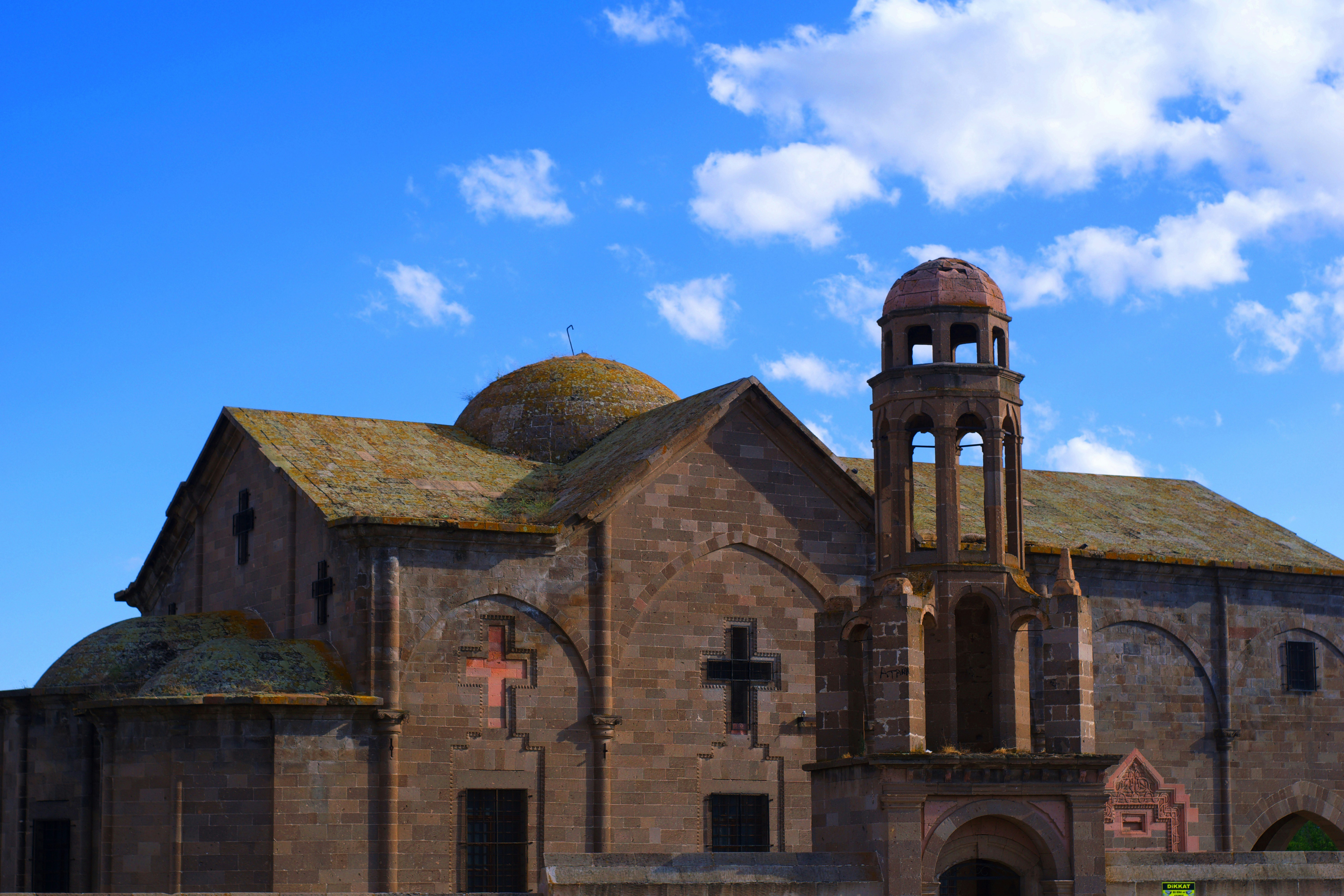 Bell Tower under a Cobalt Sky: Weathered Stone Church