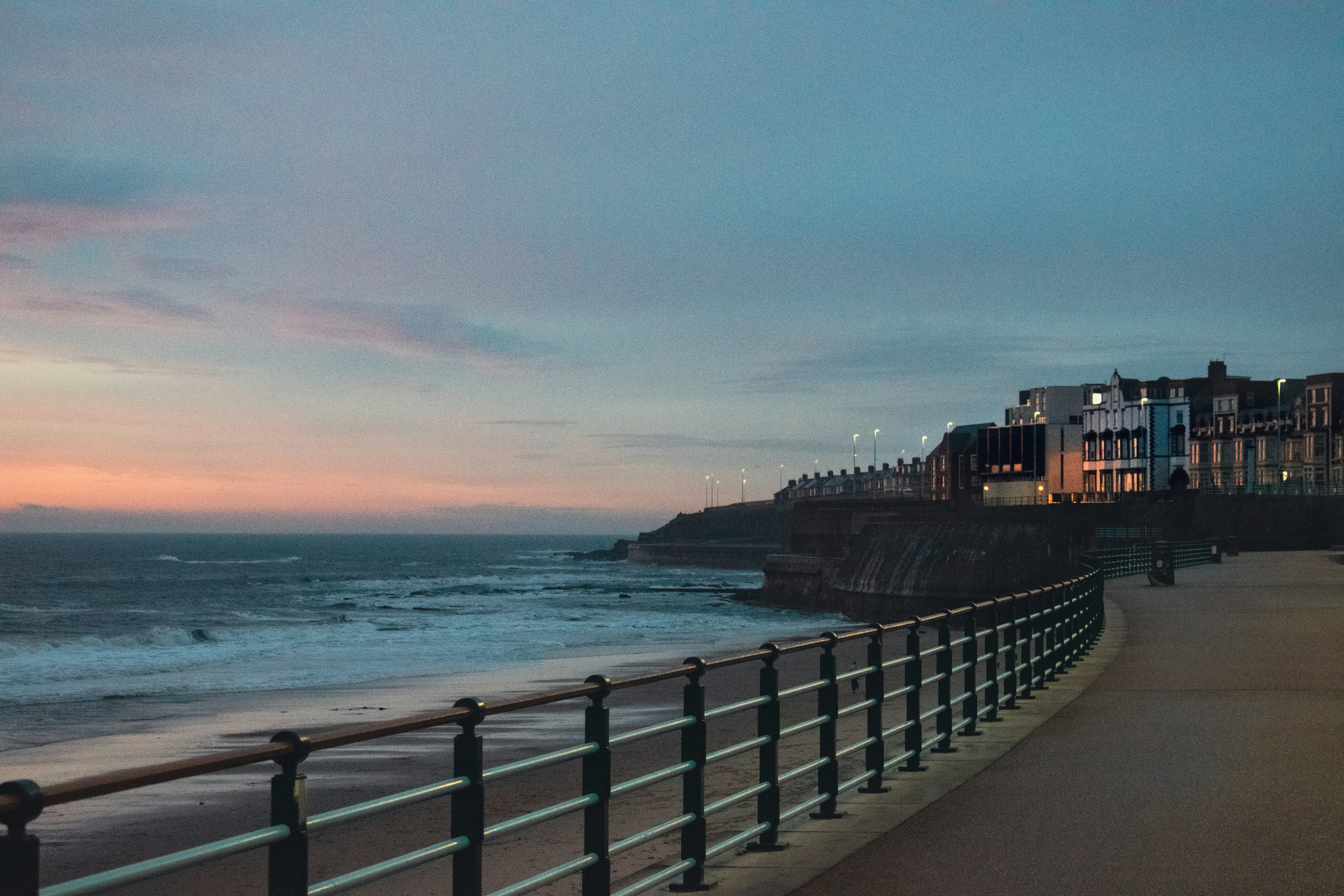 A view of the ocean from a pier at dusk photo – Free Beach Image on ...