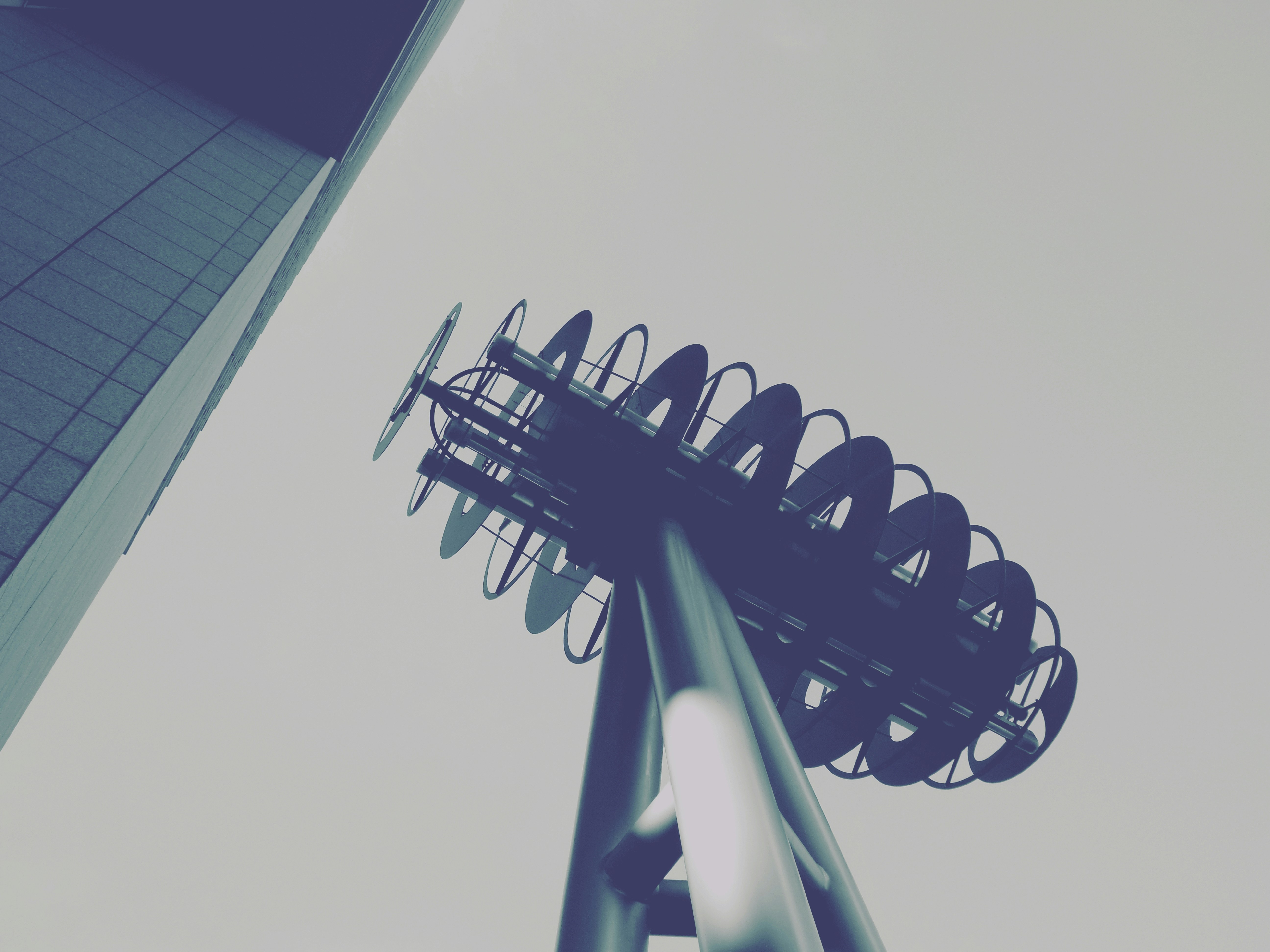 Spiral Antenna Silhouette Framed by a Glass Tower