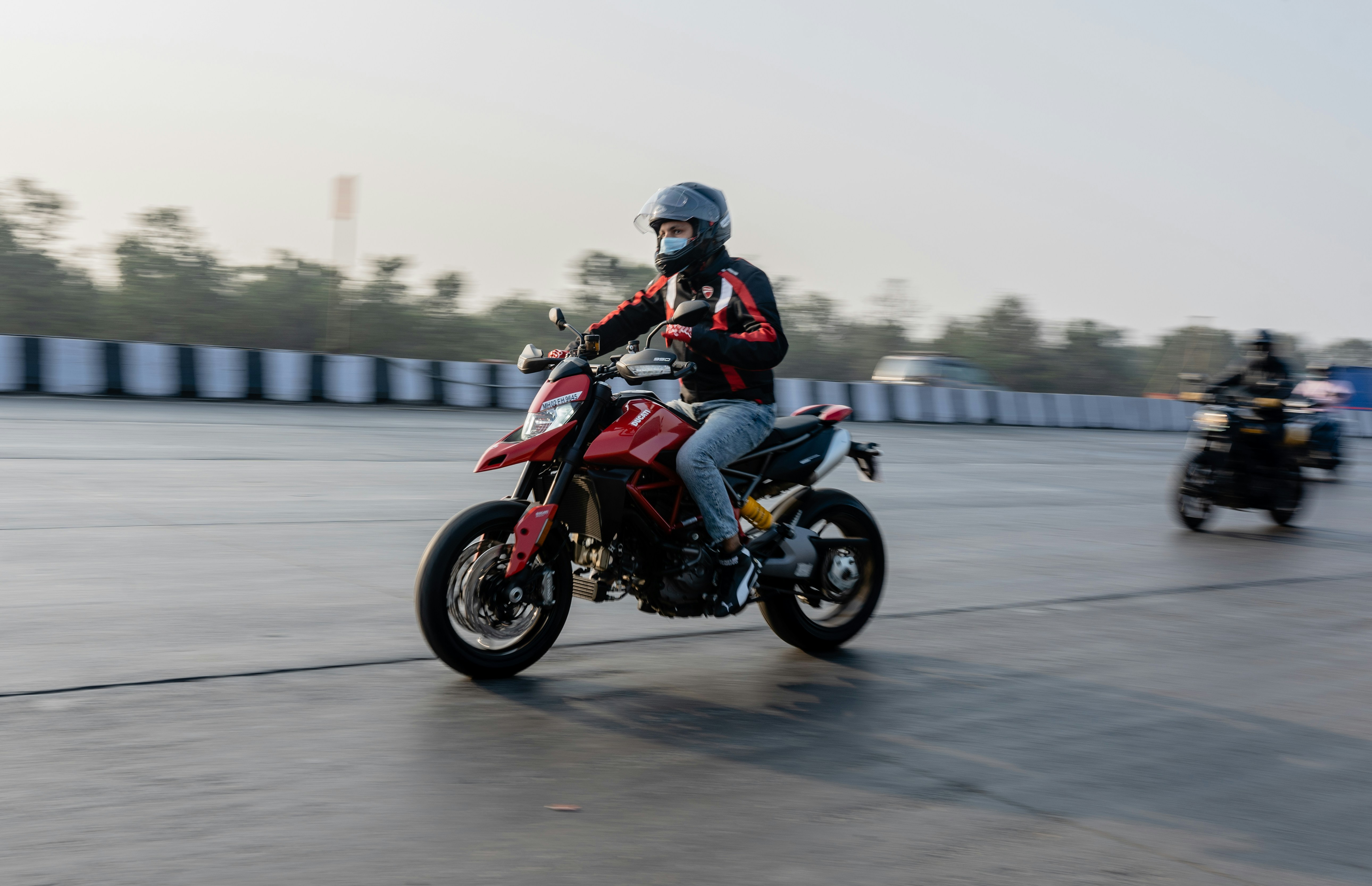 A man riding on the back of a motorcycle photo – Free Ducati motorbike ...