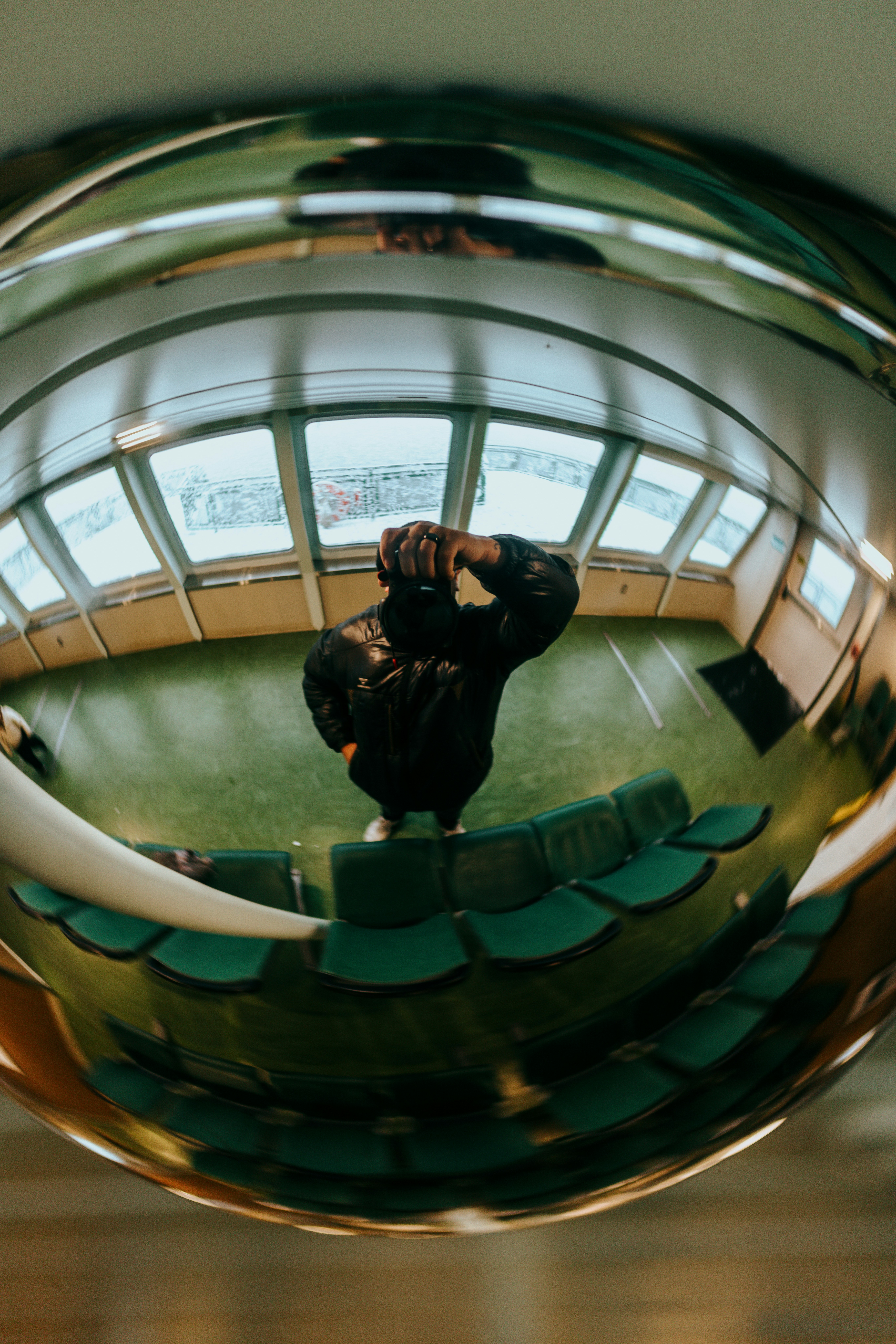 Reflected Self-Portrait in a Circular Hall of Windows