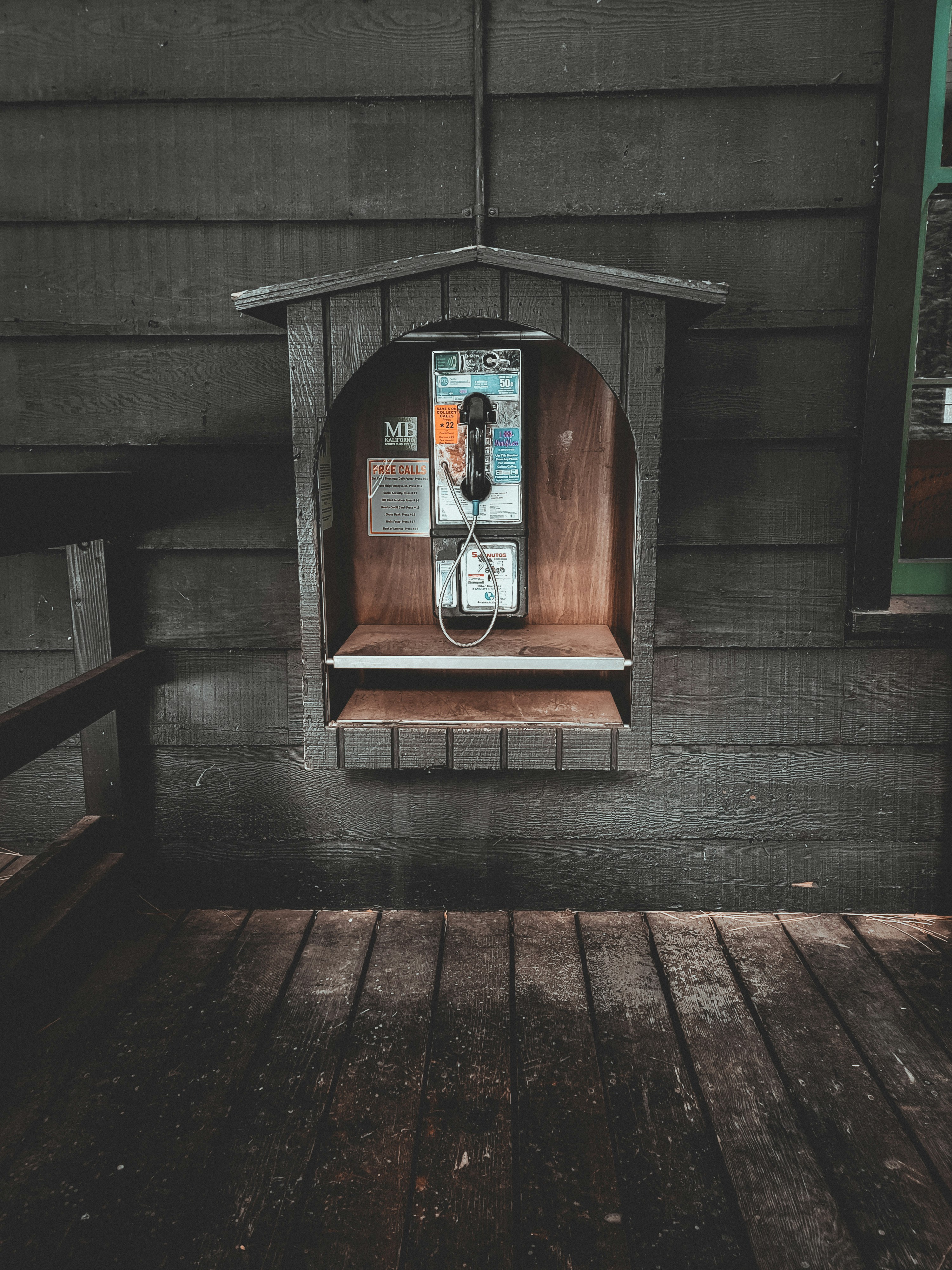 An old fashioned phone booth on a wooden deck photo – Free Forest Image ...