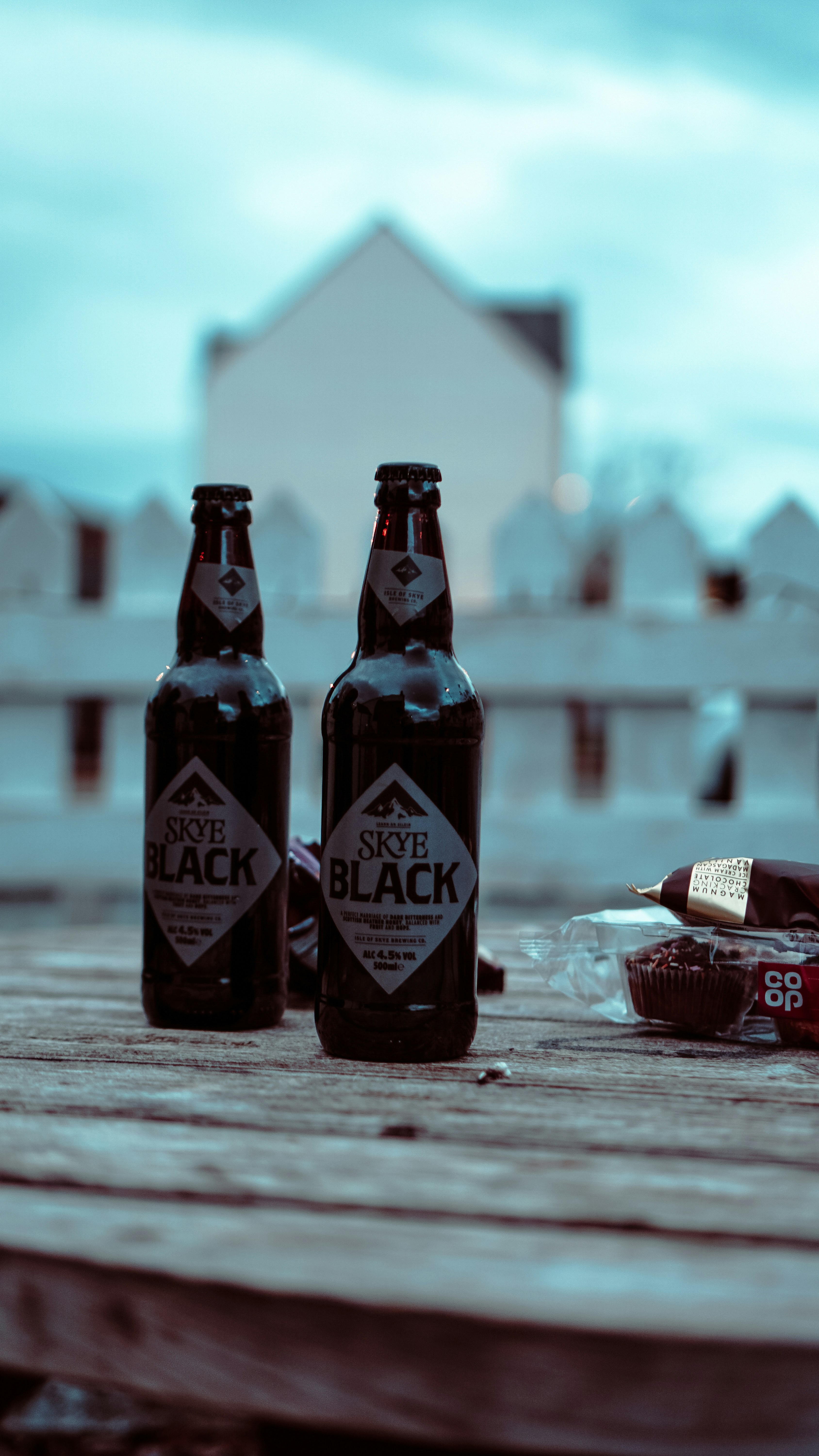 Three bottles of beer sitting on top of a wooden table photo – Free Uk ...